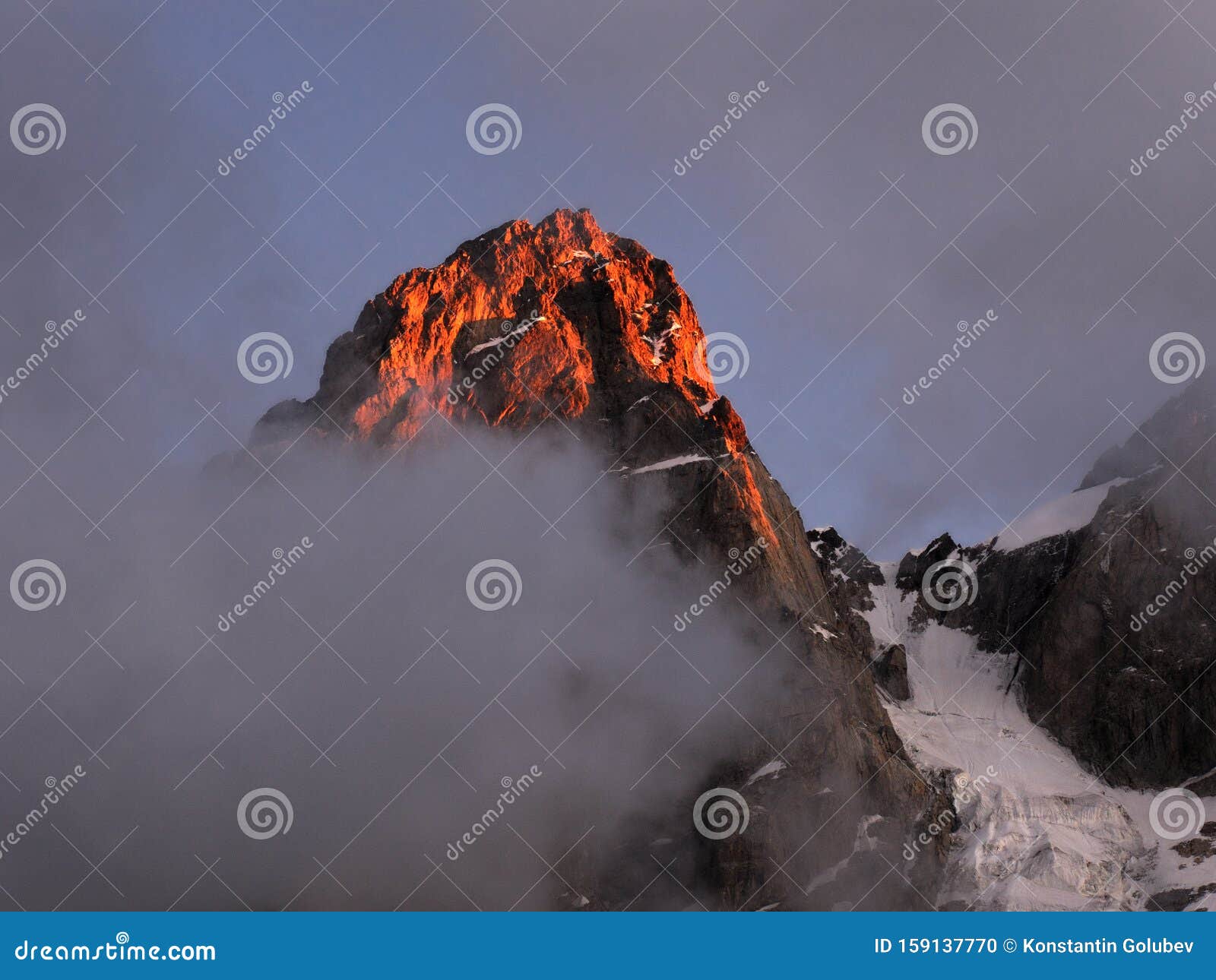 The First Rays of the Sun on a Mountain Peak Stock Photo - Image of ...
