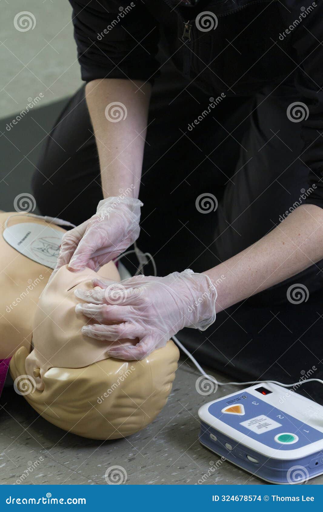 First Response Worker Demonstrates CPR and Proper Defibrillator ...