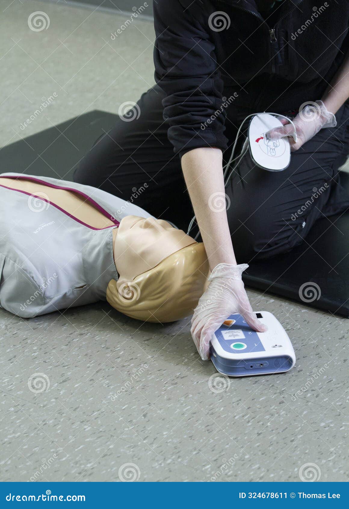 First Response Worker Demonstrates CPR and Proper Defibrillator ...