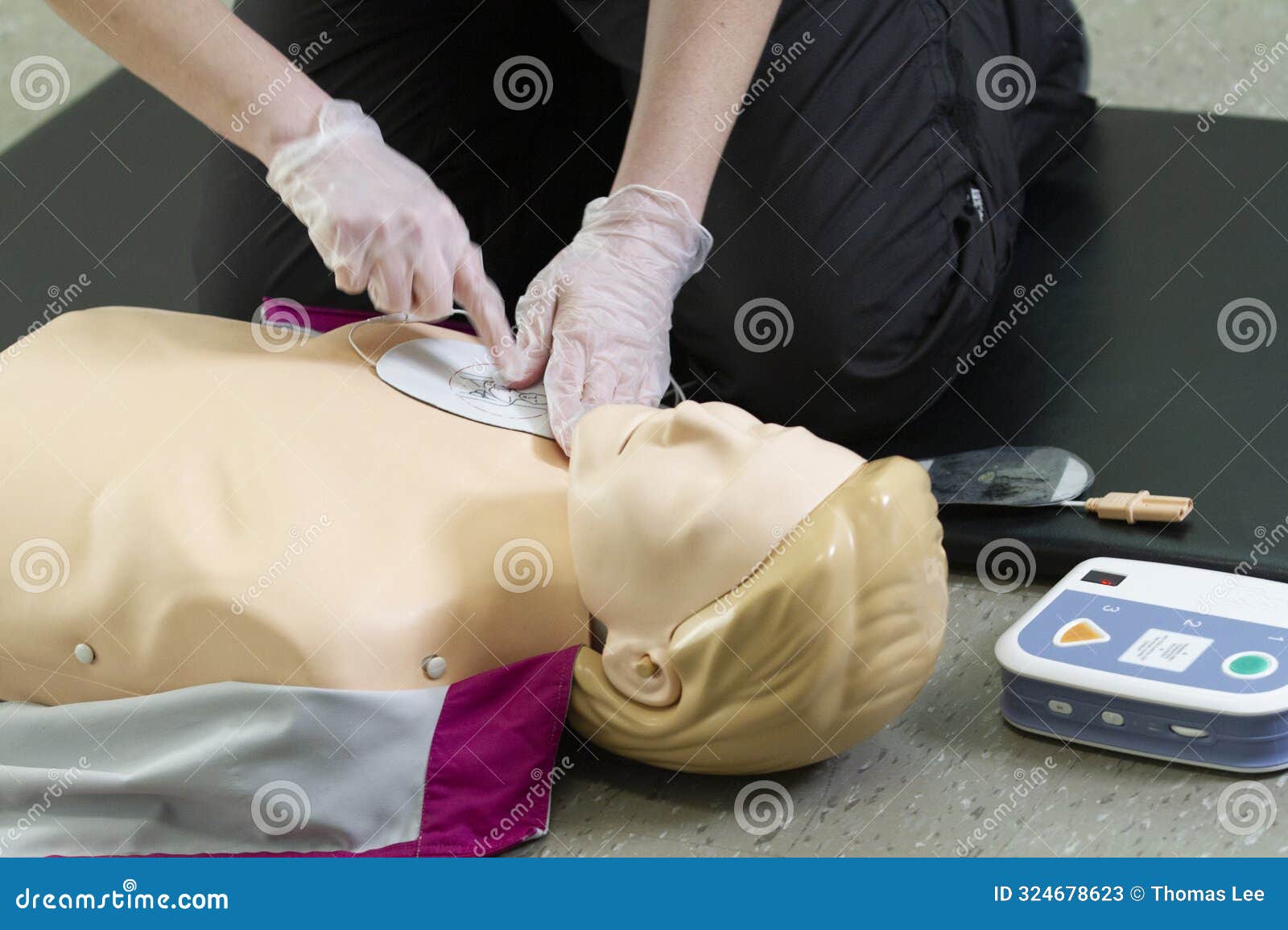 First Response Worker Demonstrates CPR and Proper Defibrillator ...