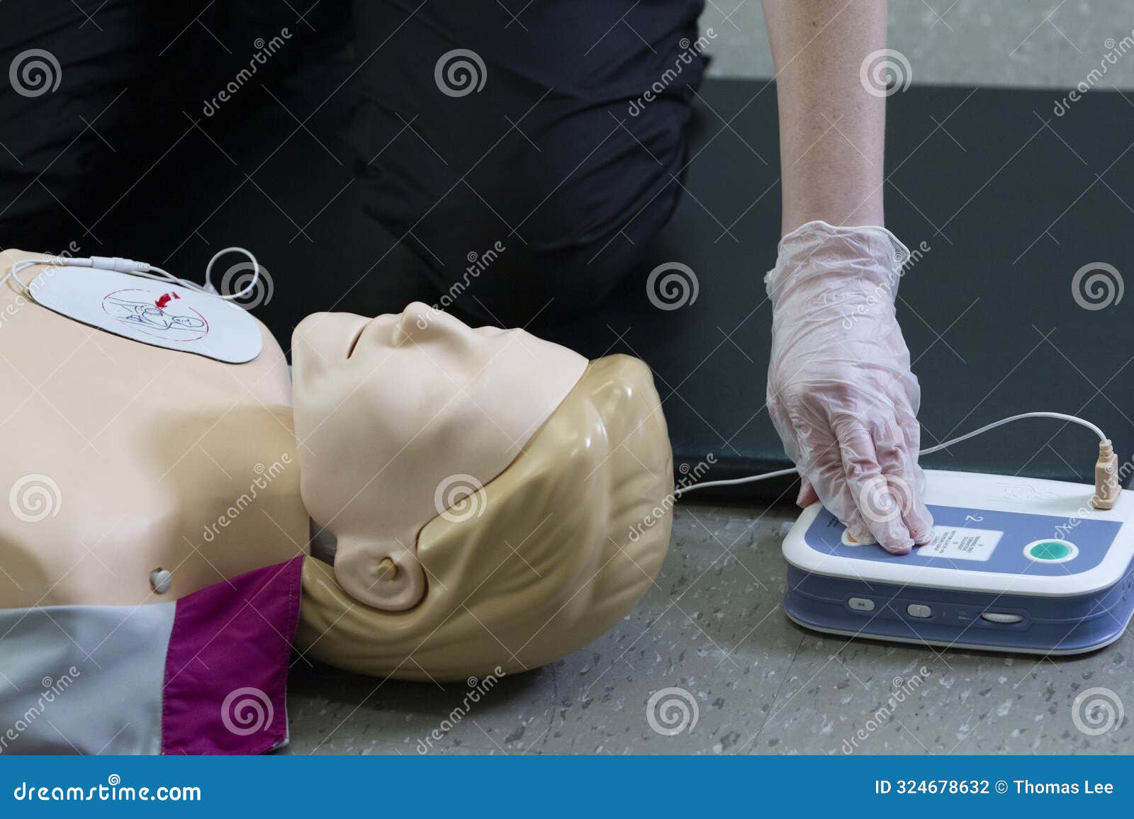 First Response Worker Demonstrates CPR and Proper Defibrillator ...