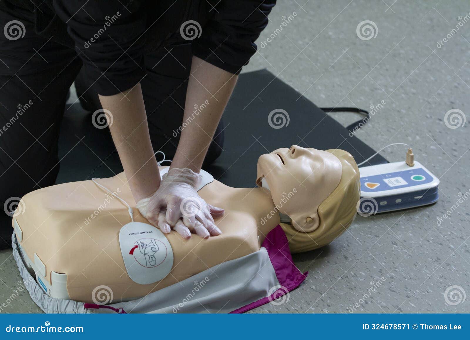First Response Worker Demonstrates CPR and Proper Defibrillator ...