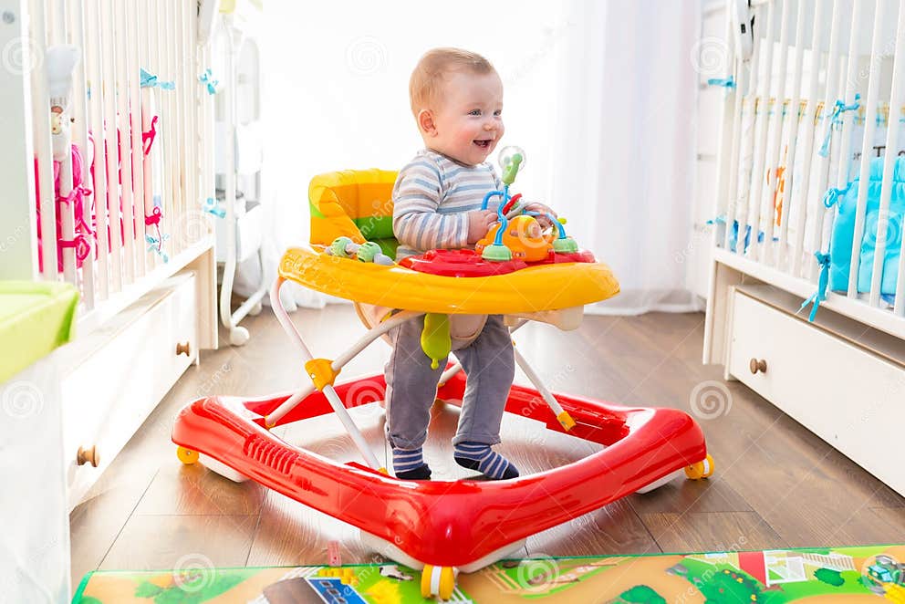 First Steps in a Baby Walker Stock Photo - Image of colorful, little ...