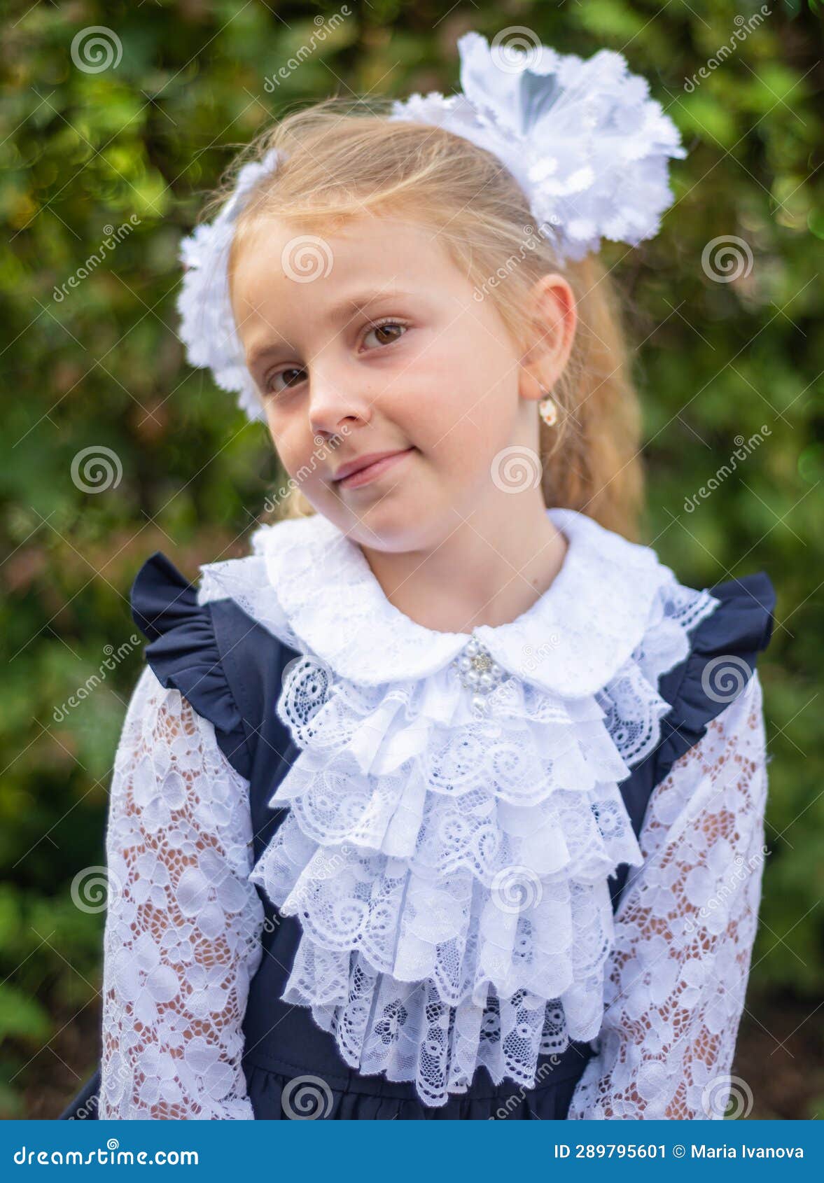 A First-grader Girl in a Beautiful Elegant Modern School Uniform on the ...