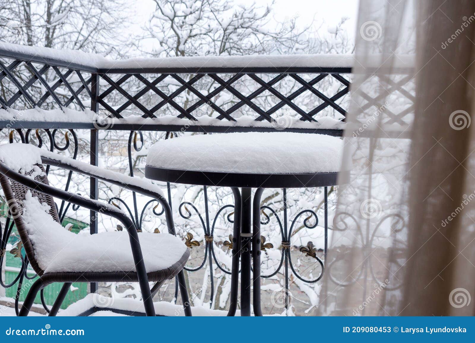 The First White Fluffy Snow on the Table and Chairs on the Wrought-iron ...