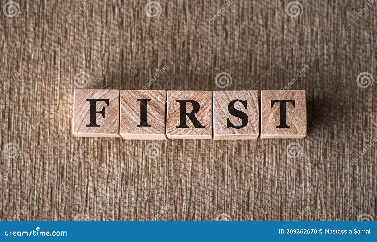 FIRST Word Written on Wooden Blocks on a Brown Background Stock Photo ...