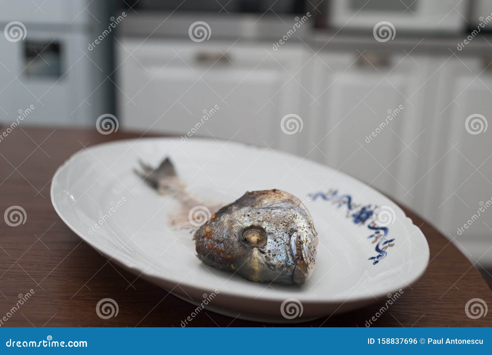 Fish Bone Left Overs with a Sliced Lemon on a White Oval Plate. Stock ...