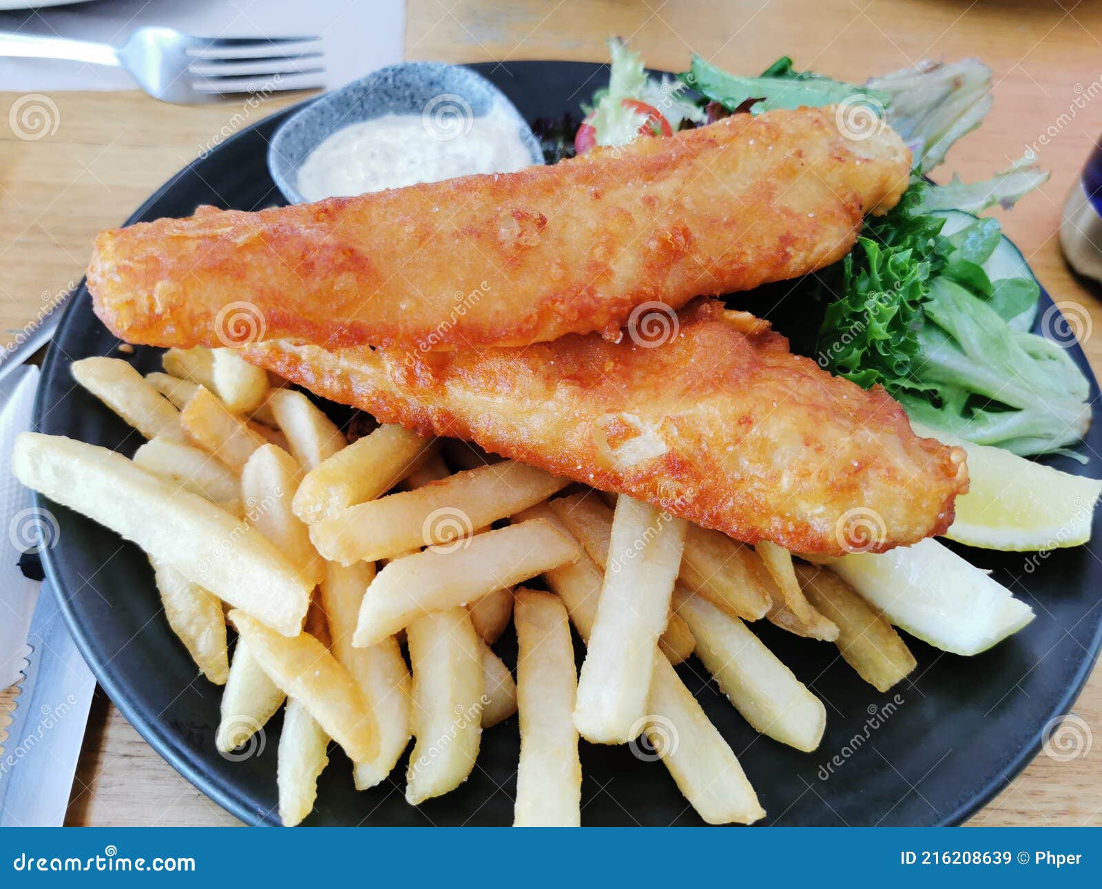 Fish and chips on a plate stock image. Image of plate - 216208639