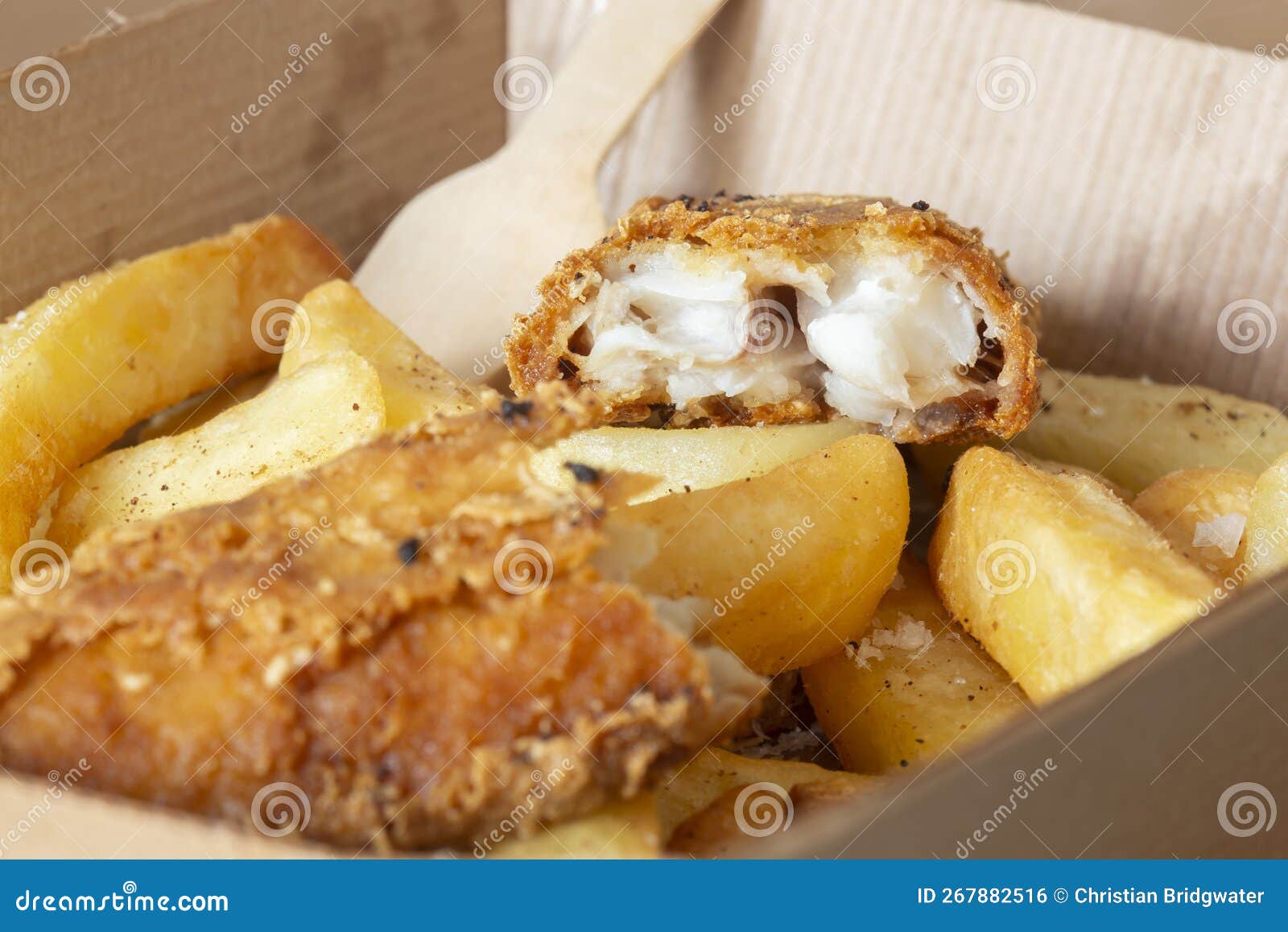 Fish and Chips Takeaway in a Cardboard Tray with a Wooden Fork ...