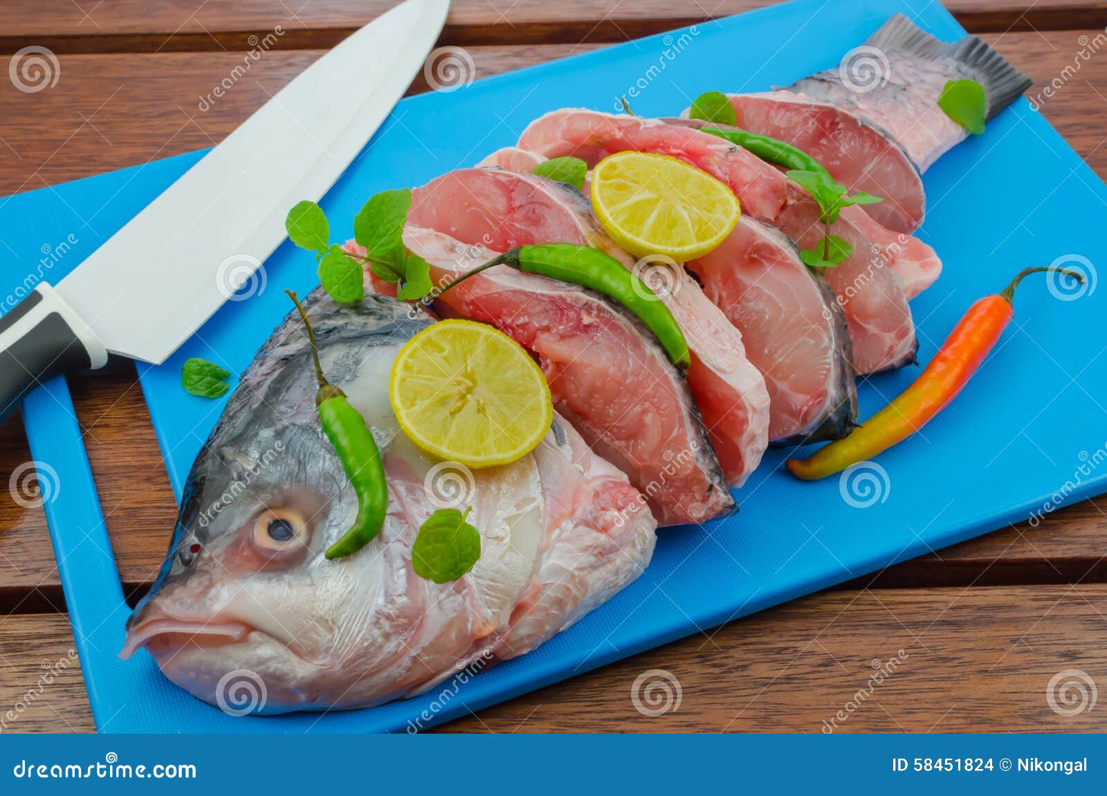 Fish on a cutting board stock photo. Image of catla, chillies - 58451824