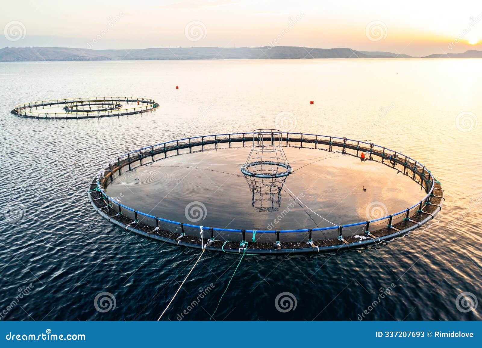 Fish Farm Structures Floating on Still Water at Sunset in a Serene Lake ...