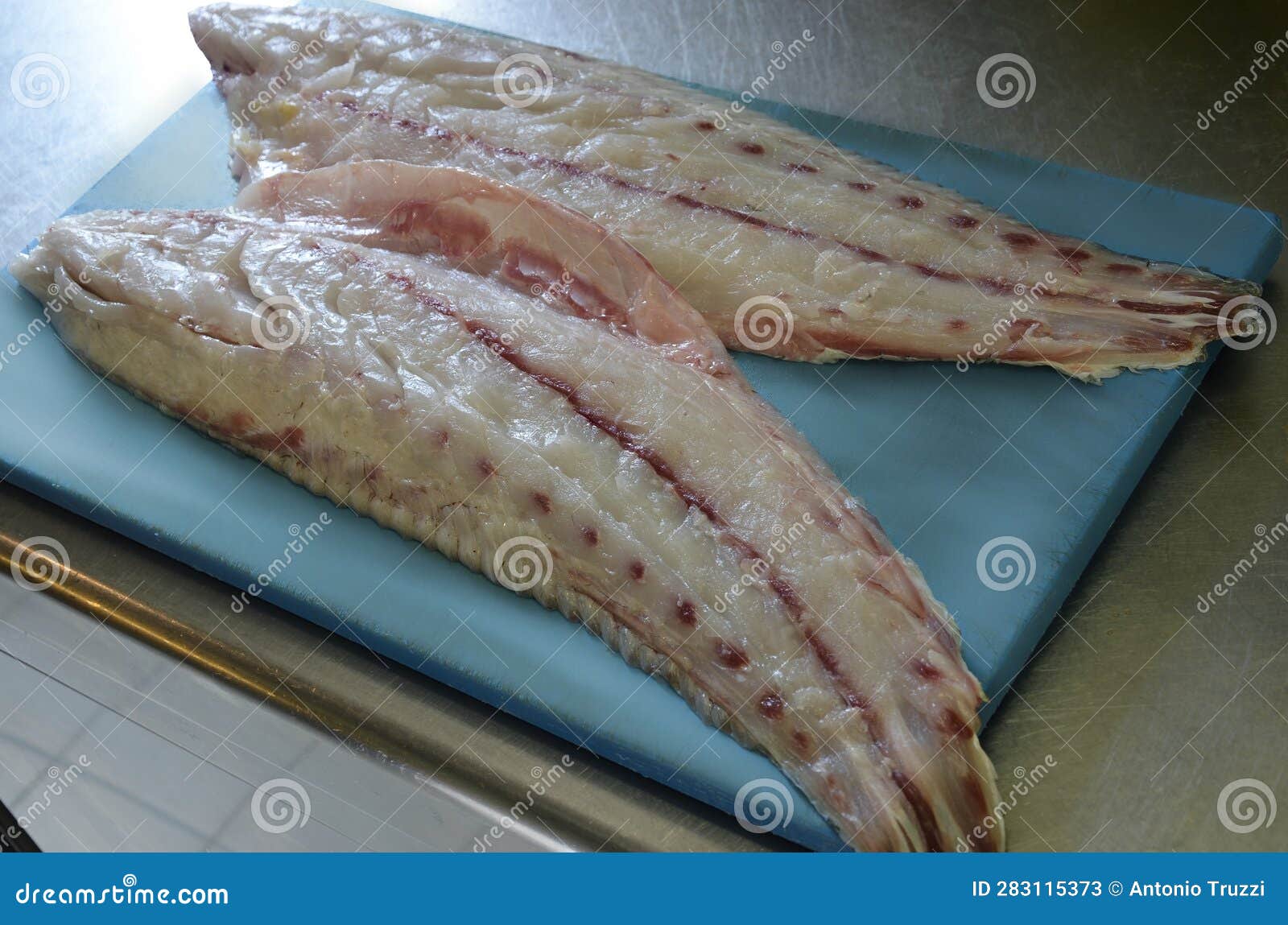Fish Fillets on a Light Blue Cutting Board Stock Image - Image of ...