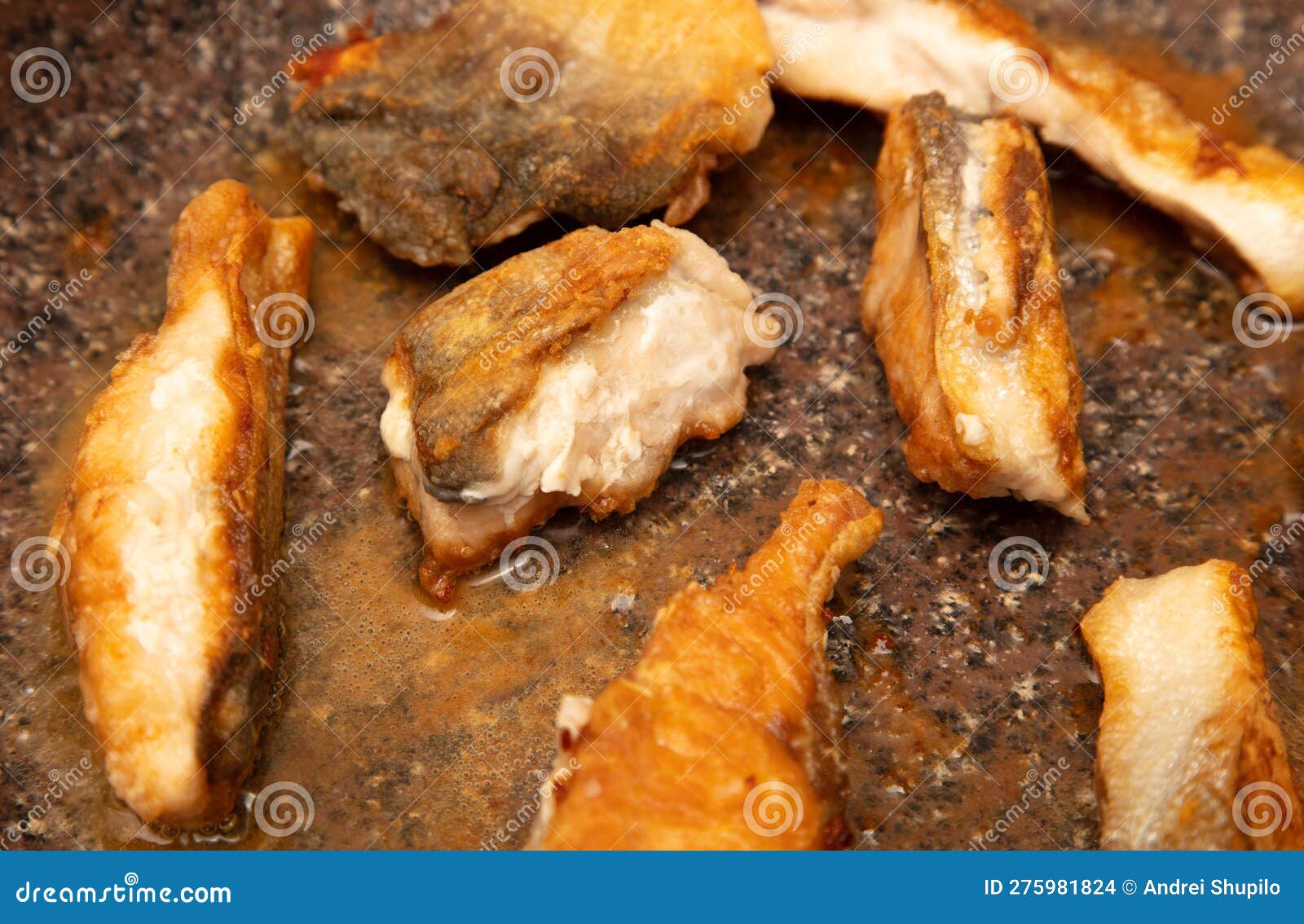 The Fish is Fried in a Frying Pan in Oil. Close-up Stock Photo - Image ...