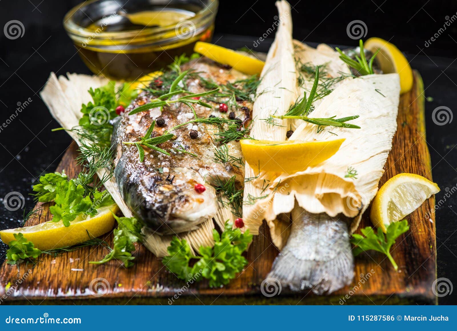 Fish Grilled and Served in Corn Husk with Herbs Stock Photo - Image of ...