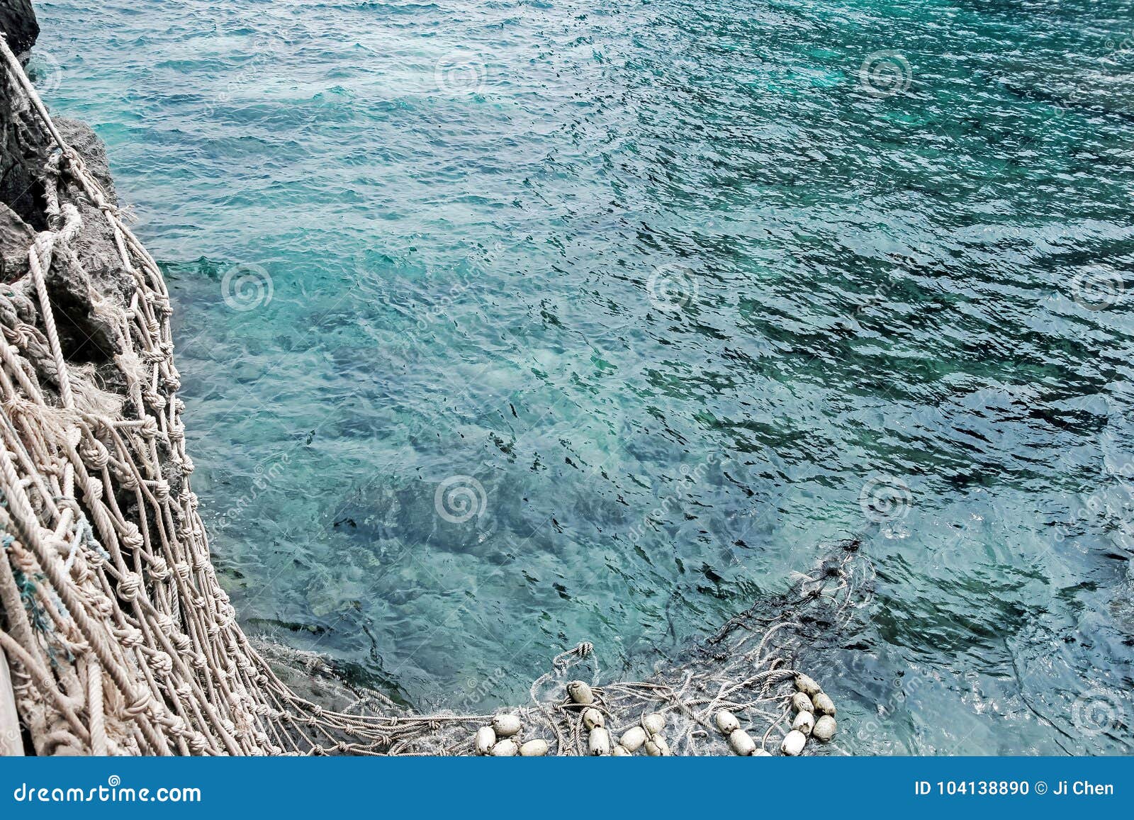 Fish net in blue ocean stock photo. Image of empty, stone - 104138890