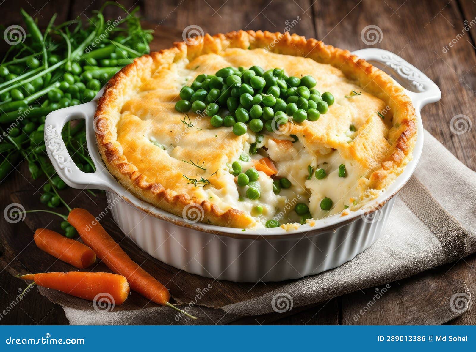 A Fish Pie with Mashed Potatoes, Cheese, Peas, and Carrots Stock ...