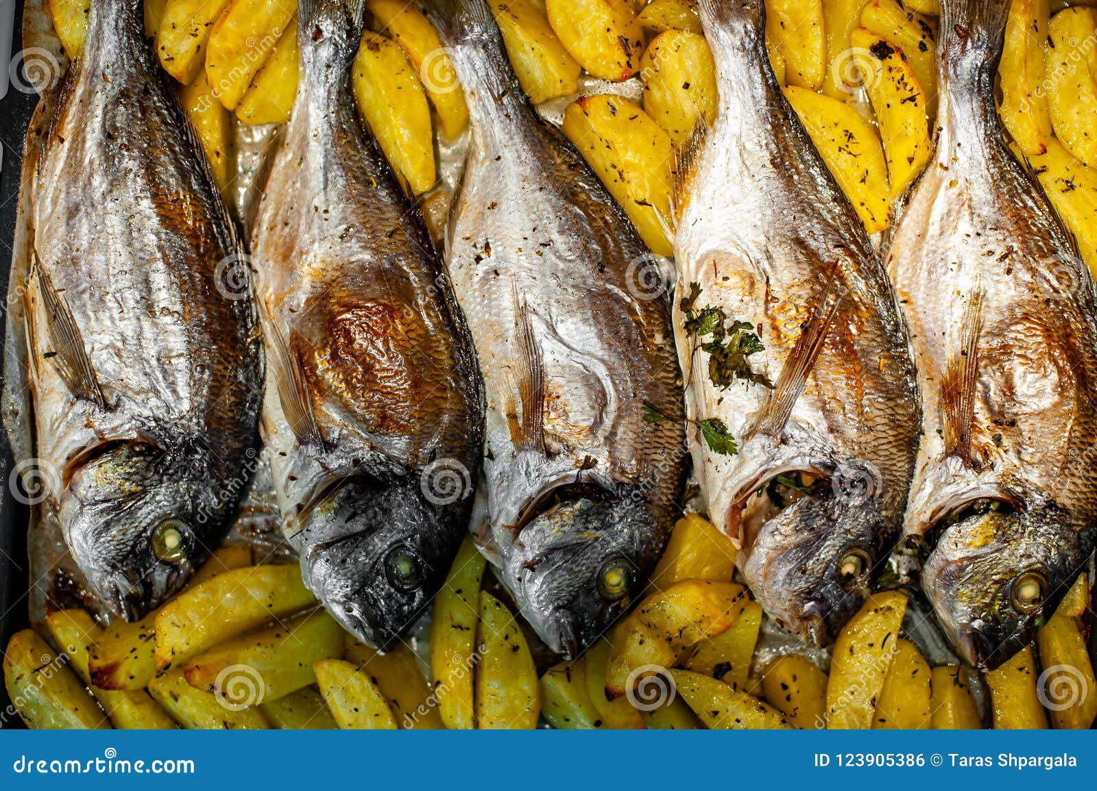 Fish Sparus Aurata for Baking with Potatoes and Greens Stock Photo ...