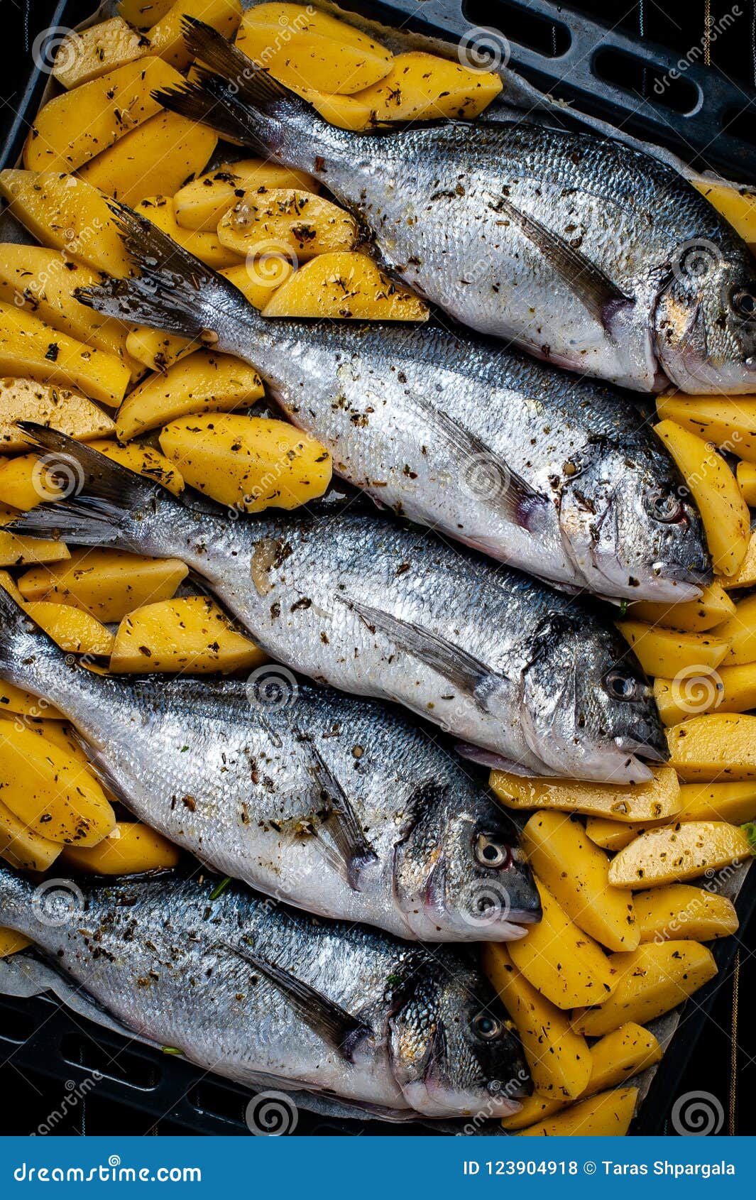 Fish Sparus Aurata for Baking with Potatoes and Greens Stock Photo ...