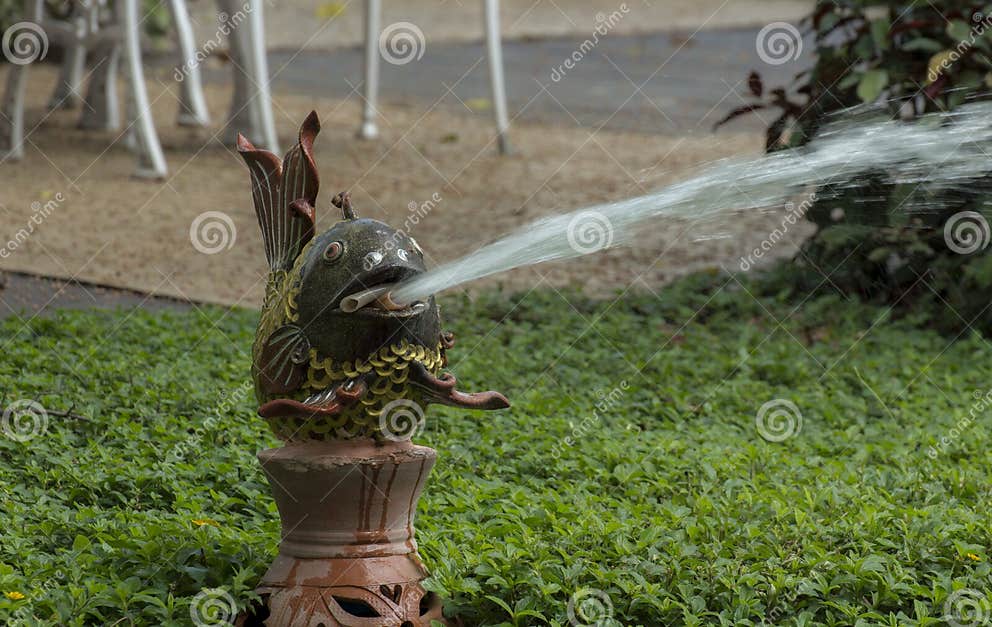 Fish statue spout water stock image. Image of fish, garden - 85569097