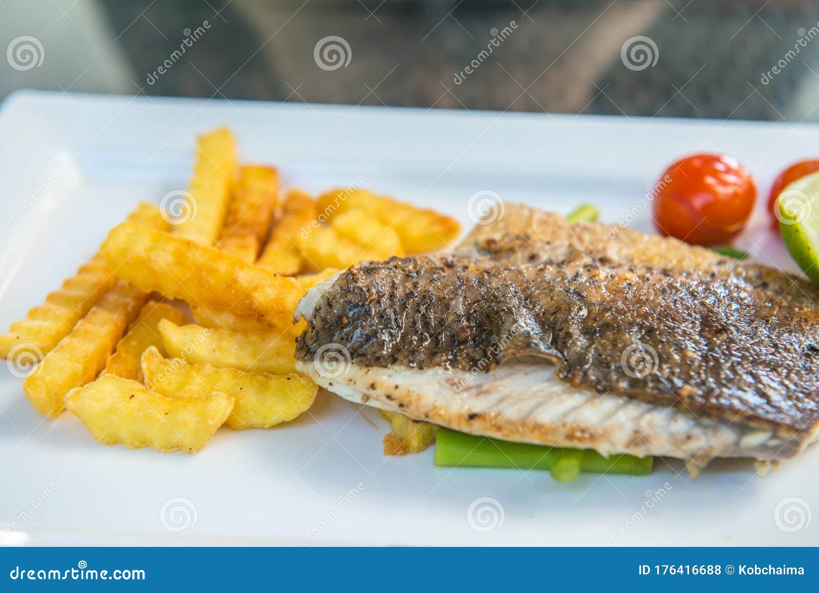 Fish steak on white plate stock photo. Image of omega - 176416688