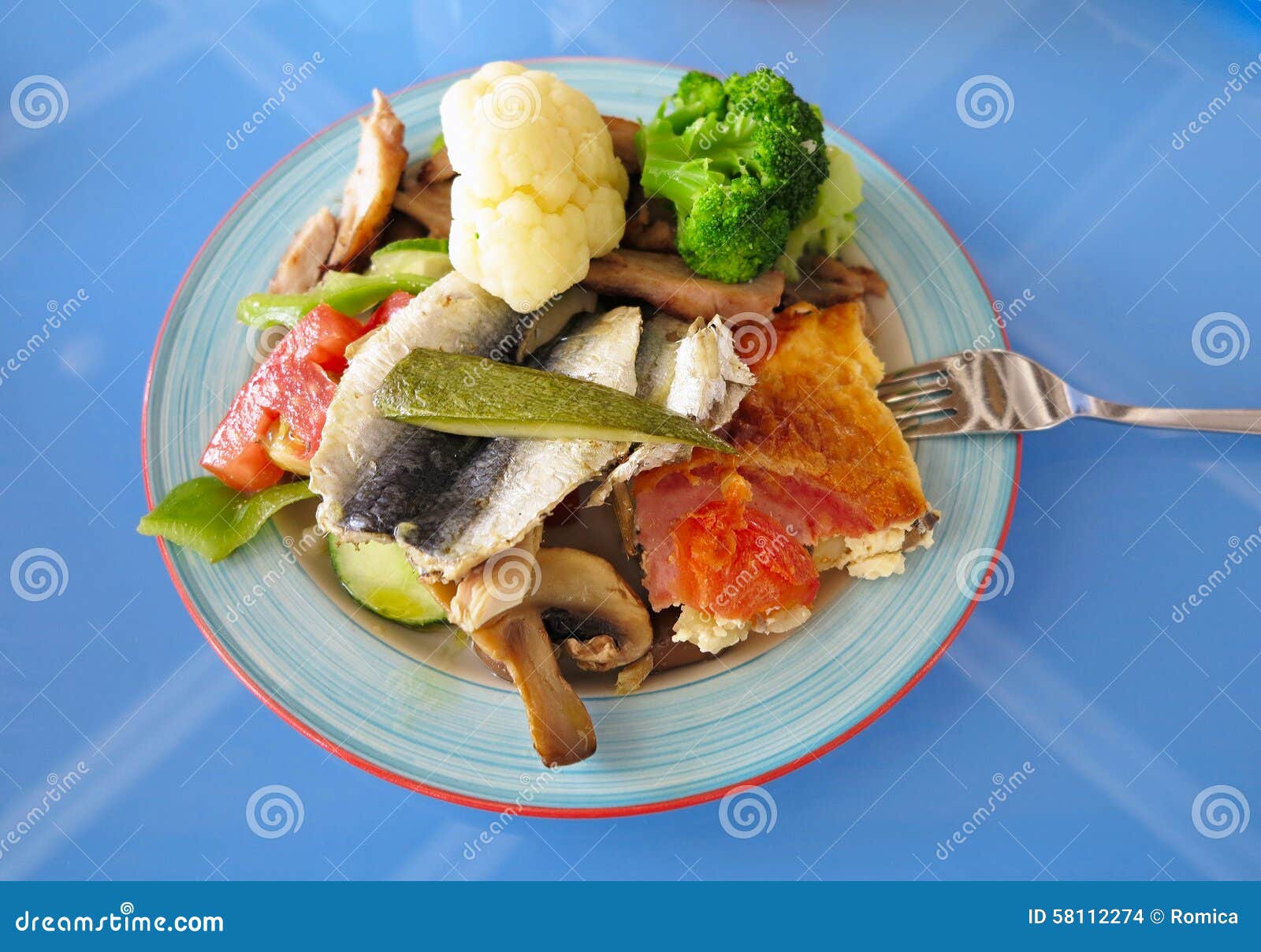 Fish and Vegetables on Dish Over Blue Table Stock Photo - Image of ...