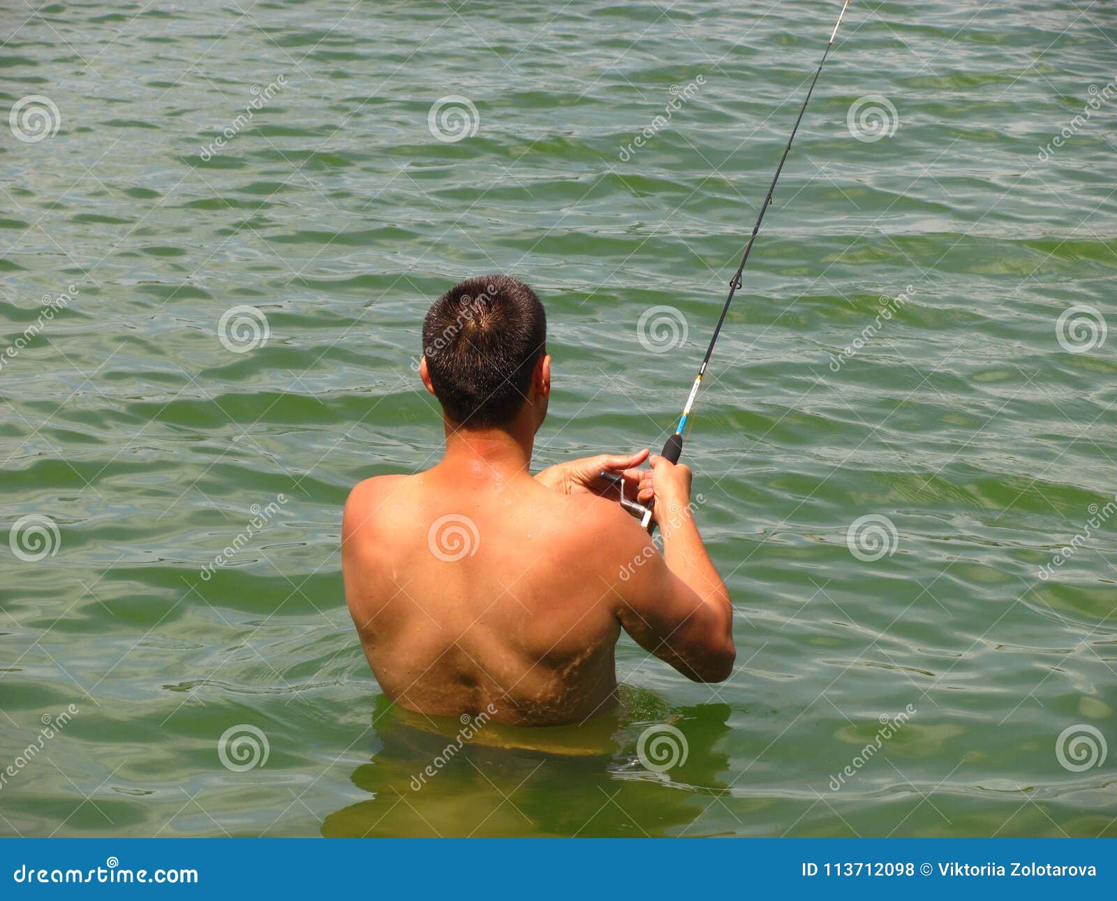 Fisherman Catches a Fish in Water Stock Photo - Image of inwater ...
