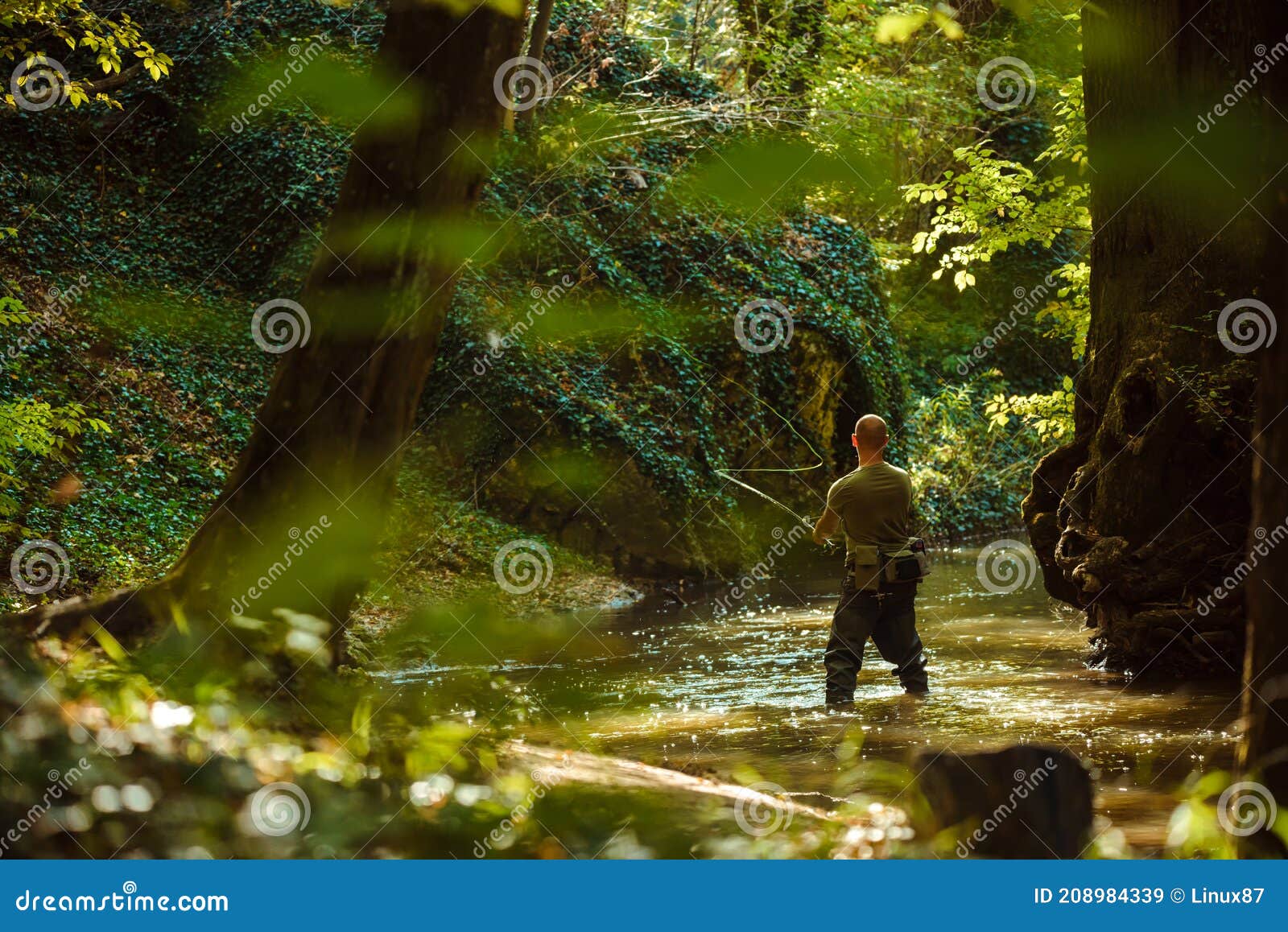 A Fisherman Fishing in the Flowing Stream Stock Image - Image of ...