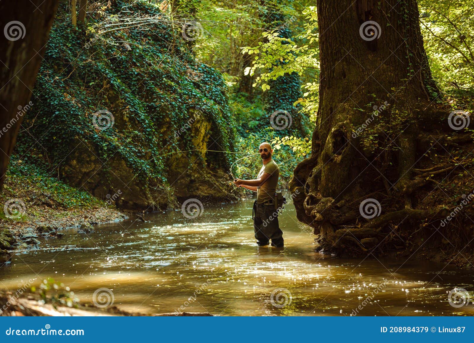 A Fisherman Fishing in the Flowing Stream Stock Image - Image of ...