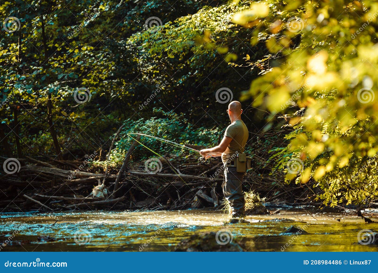A Fisherman Fishing in the Flowing Stream Stock Photo - Image of ...