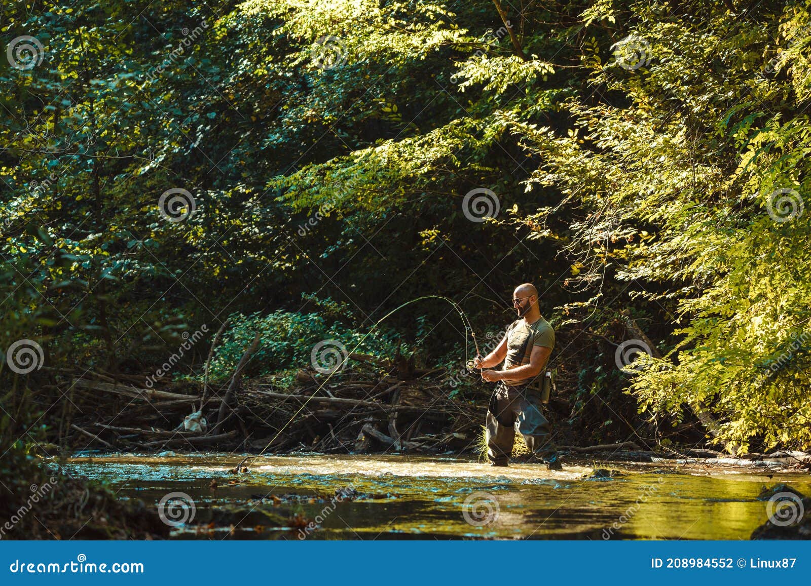 A Fisherman Fishing in the Flowing Stream Stock Photo - Image of line ...