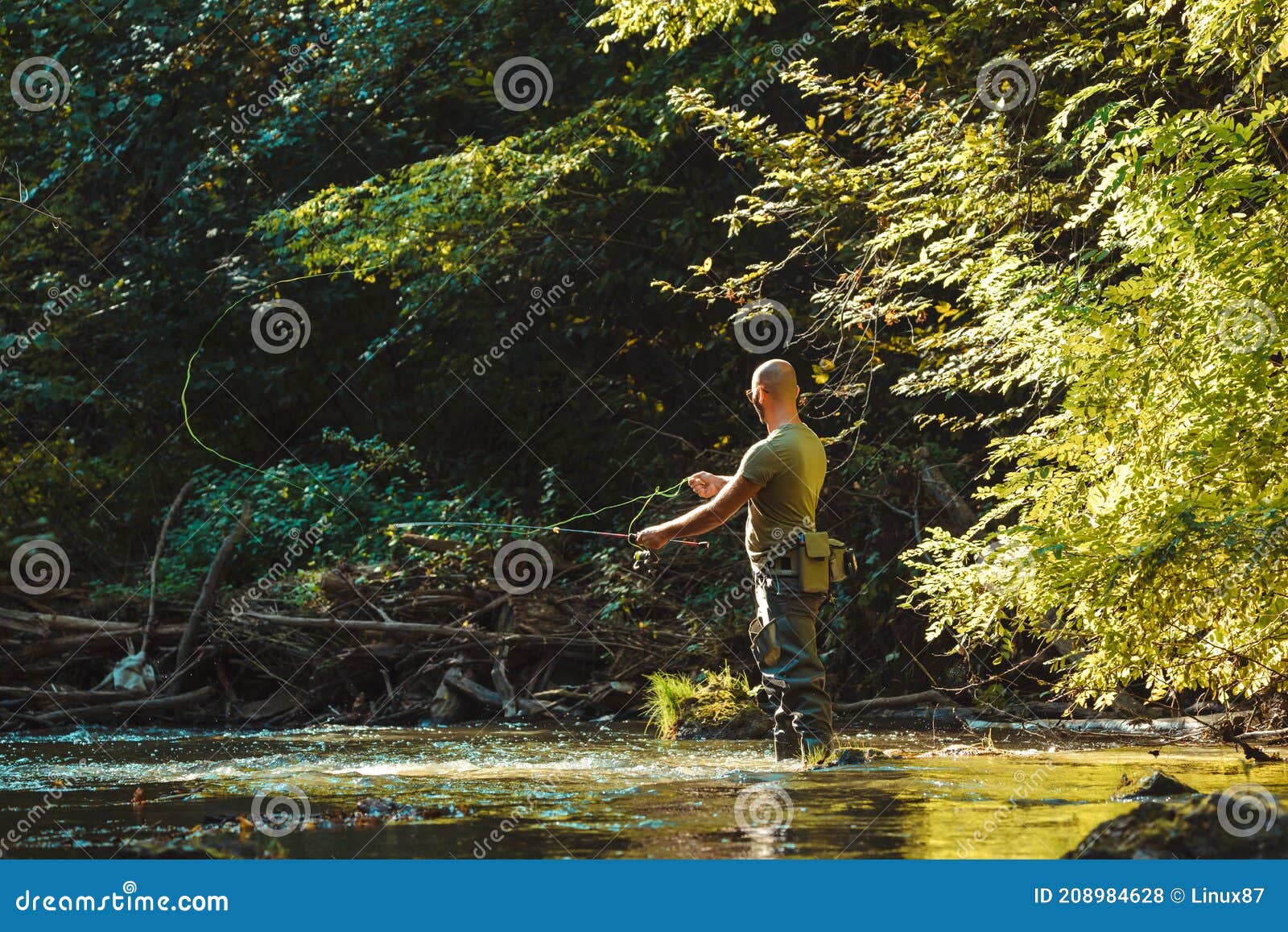A Fisherman Fishing in the Flowing Stream Stock Photo - Image of creek ...