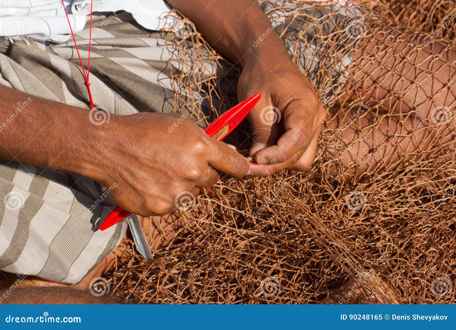 A Fisherman Fixing His Fishing Net Stock Photo | CartoonDealer.com ...
