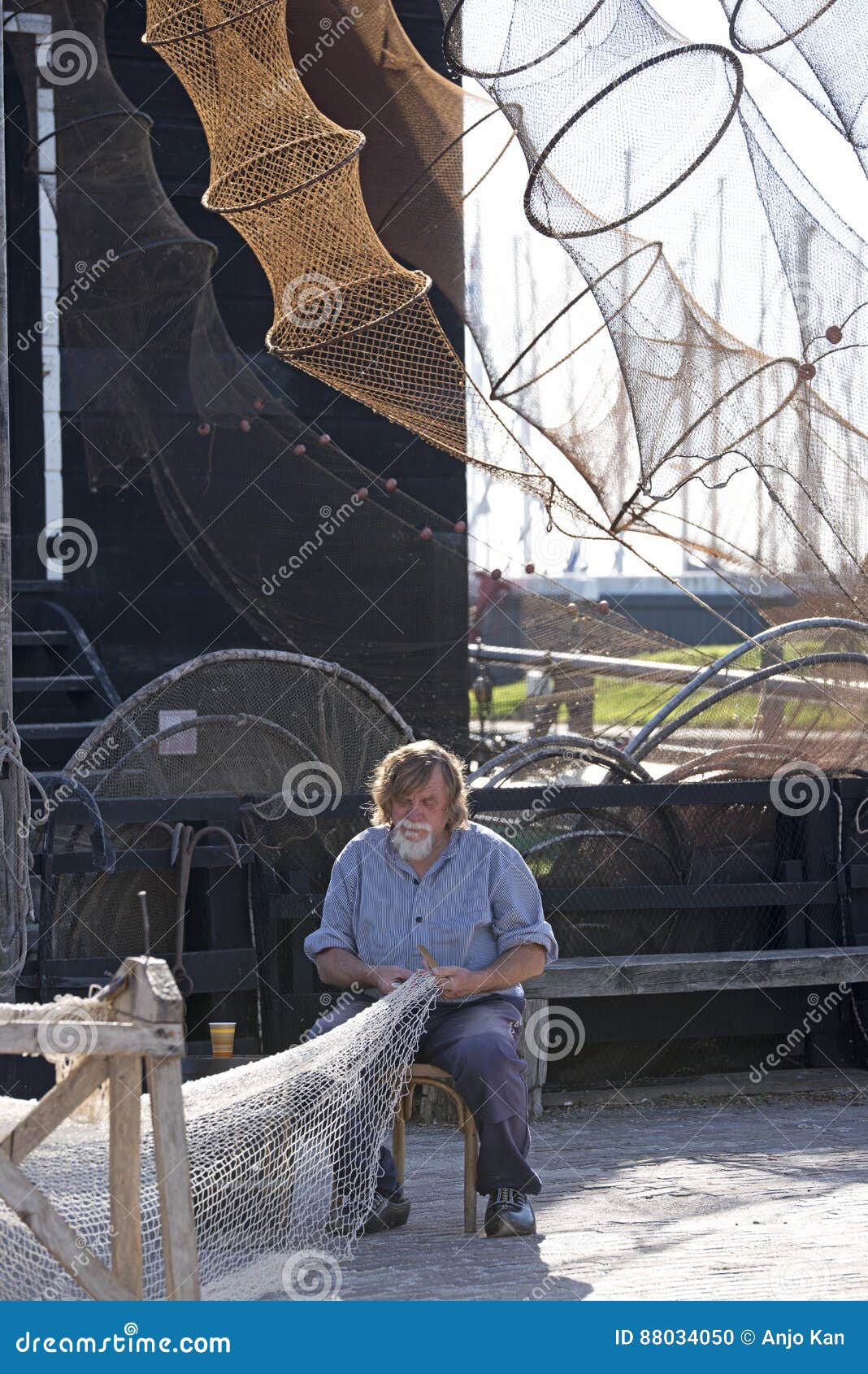 Fisherman fixing his nets editorial image. Image of travel - 88034050