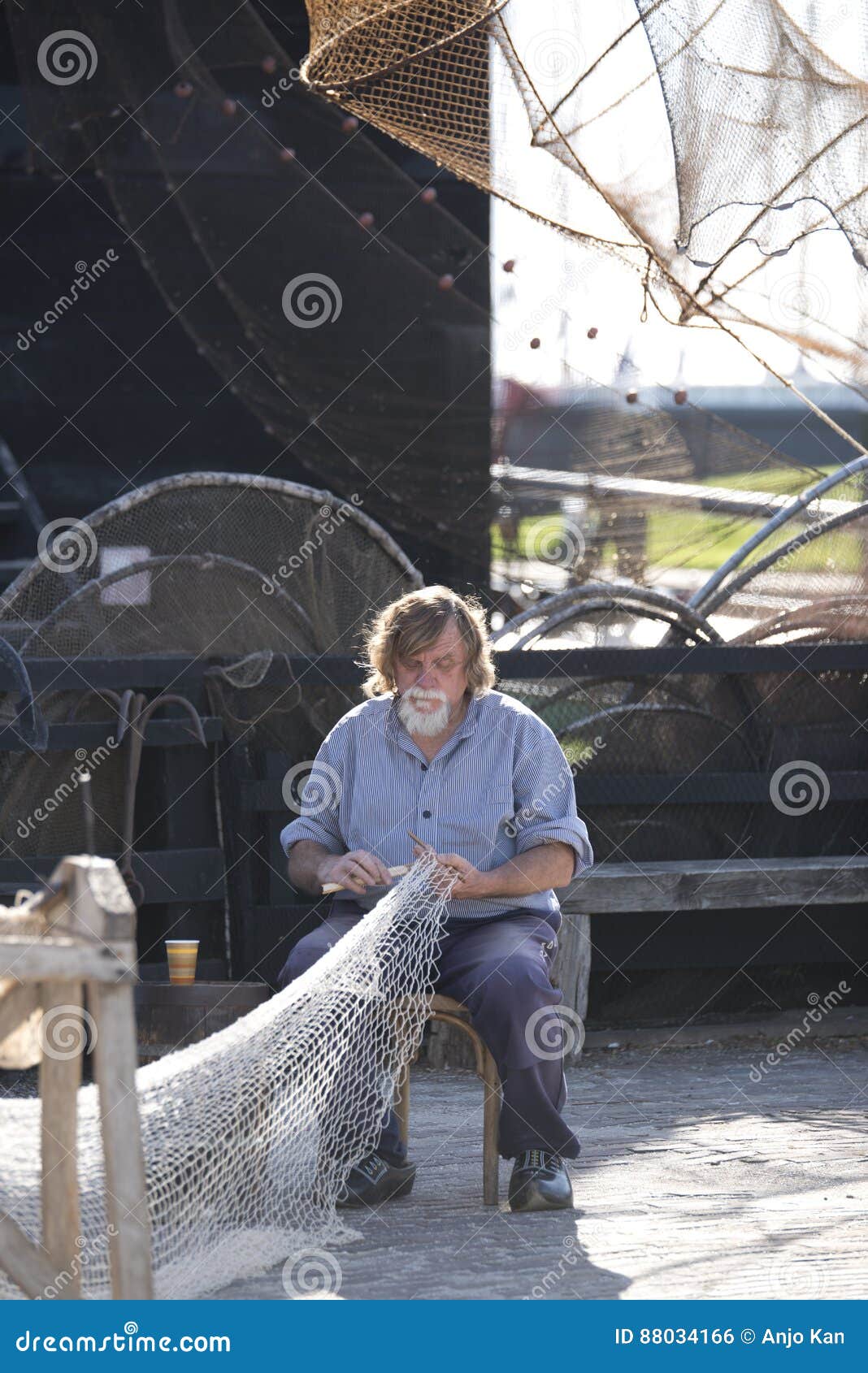 Fisherman fixing his nets editorial photo. Image of zuiderzee - 88034166