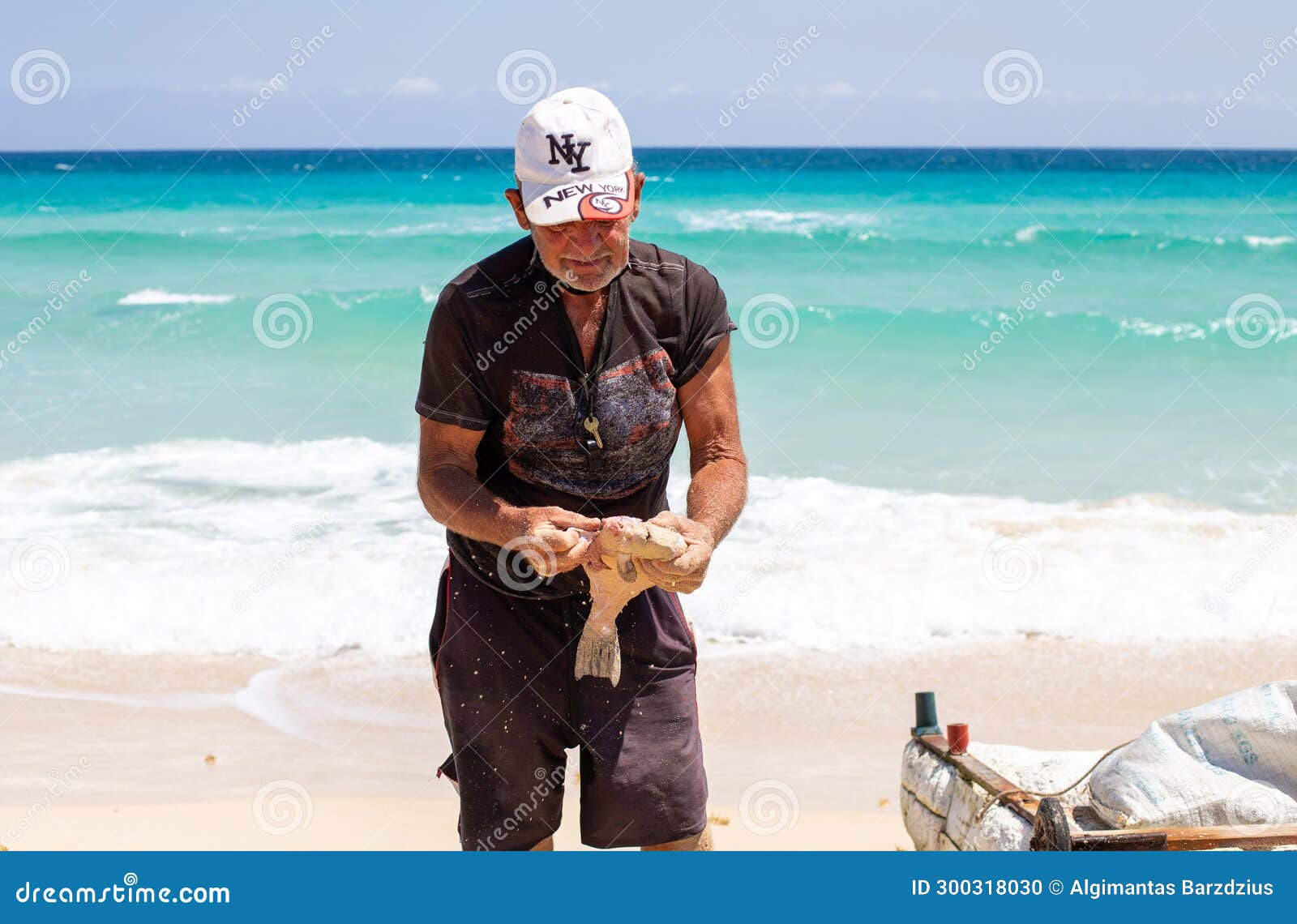 A Fisherman Guts a Freshly Caught Fish on a Cuban Beach 04 28 2022 ...