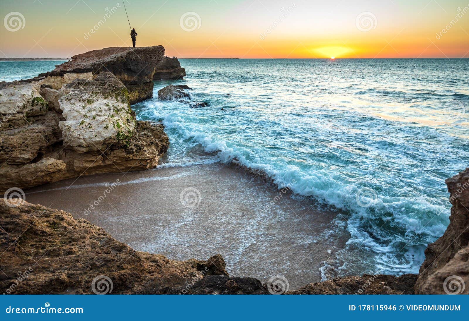 Fisherman on a High Cliff Over Dramatic Ocean at Sunset Stock Photo ...