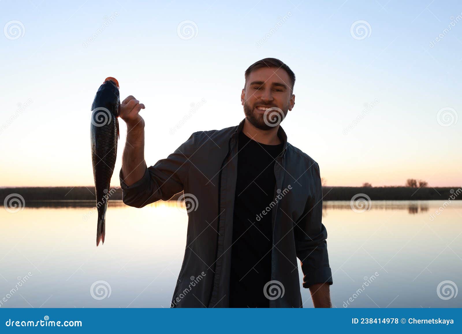 Fisherman Holding Caught Fish at Riverside. Recreational Activity Stock ...
