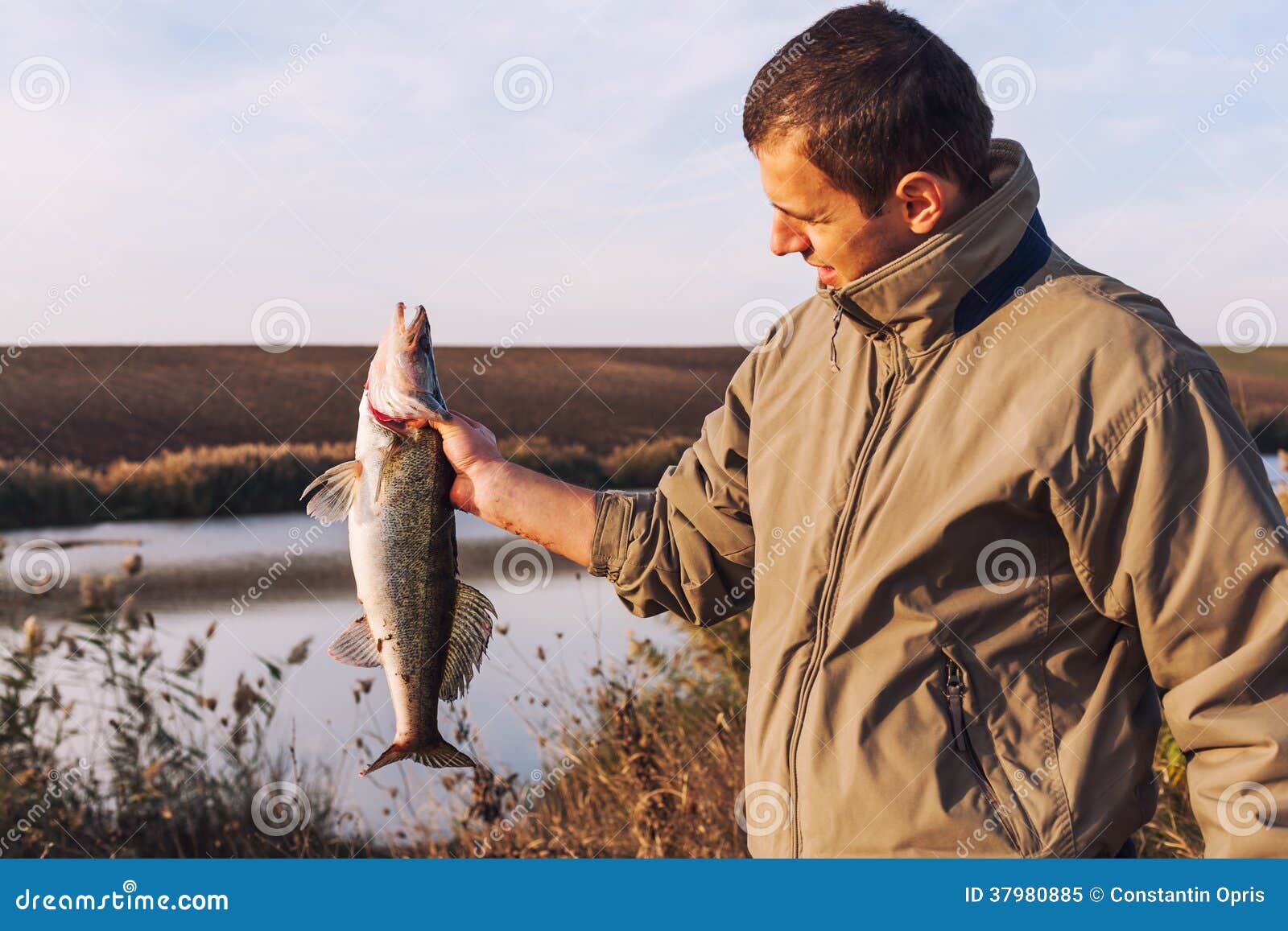 Fisherman holding fish stock image. Image of standing - 37980885