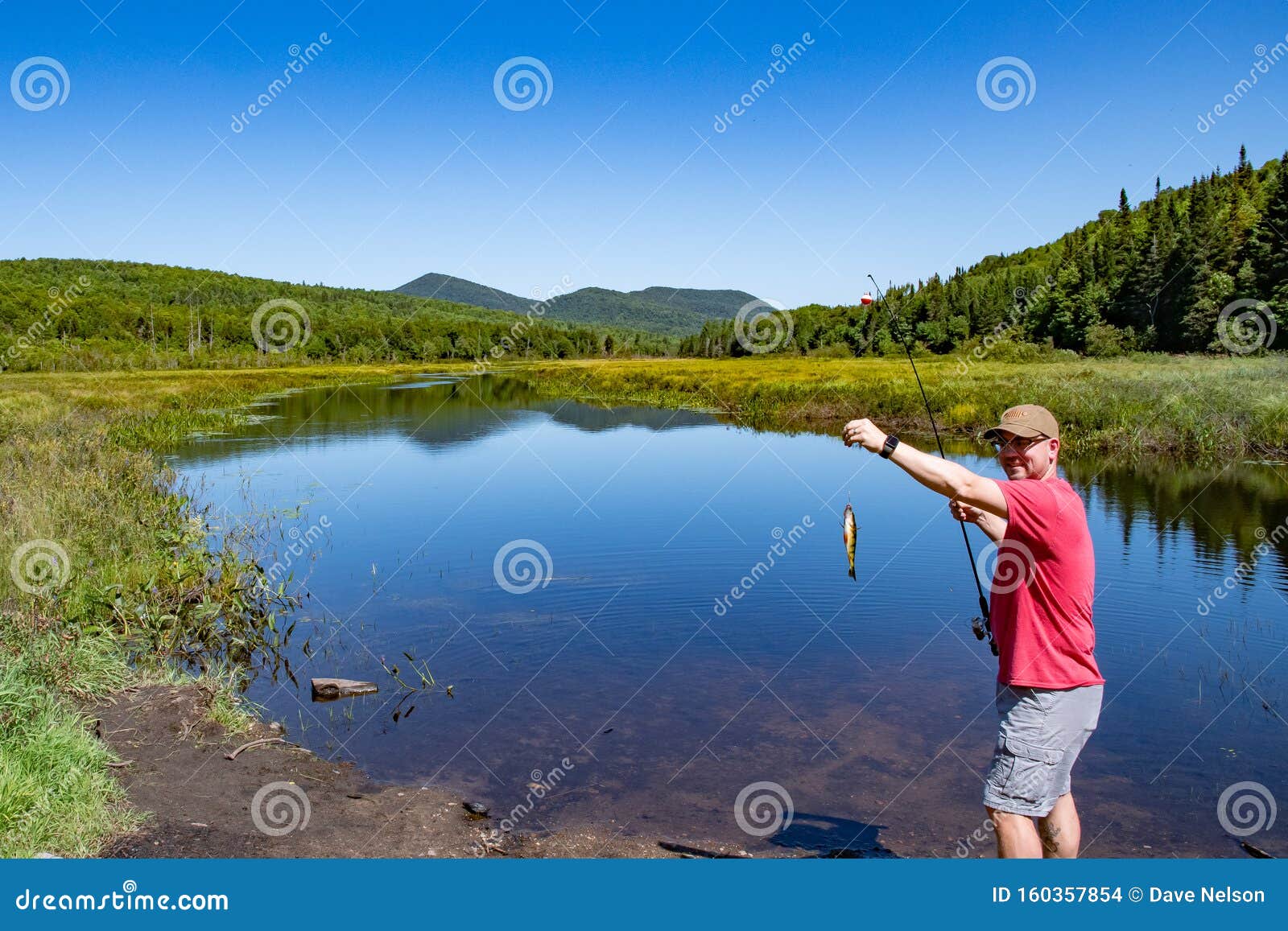 Fisherman with tiny fish editorial stock image. Image of sport - 160357854