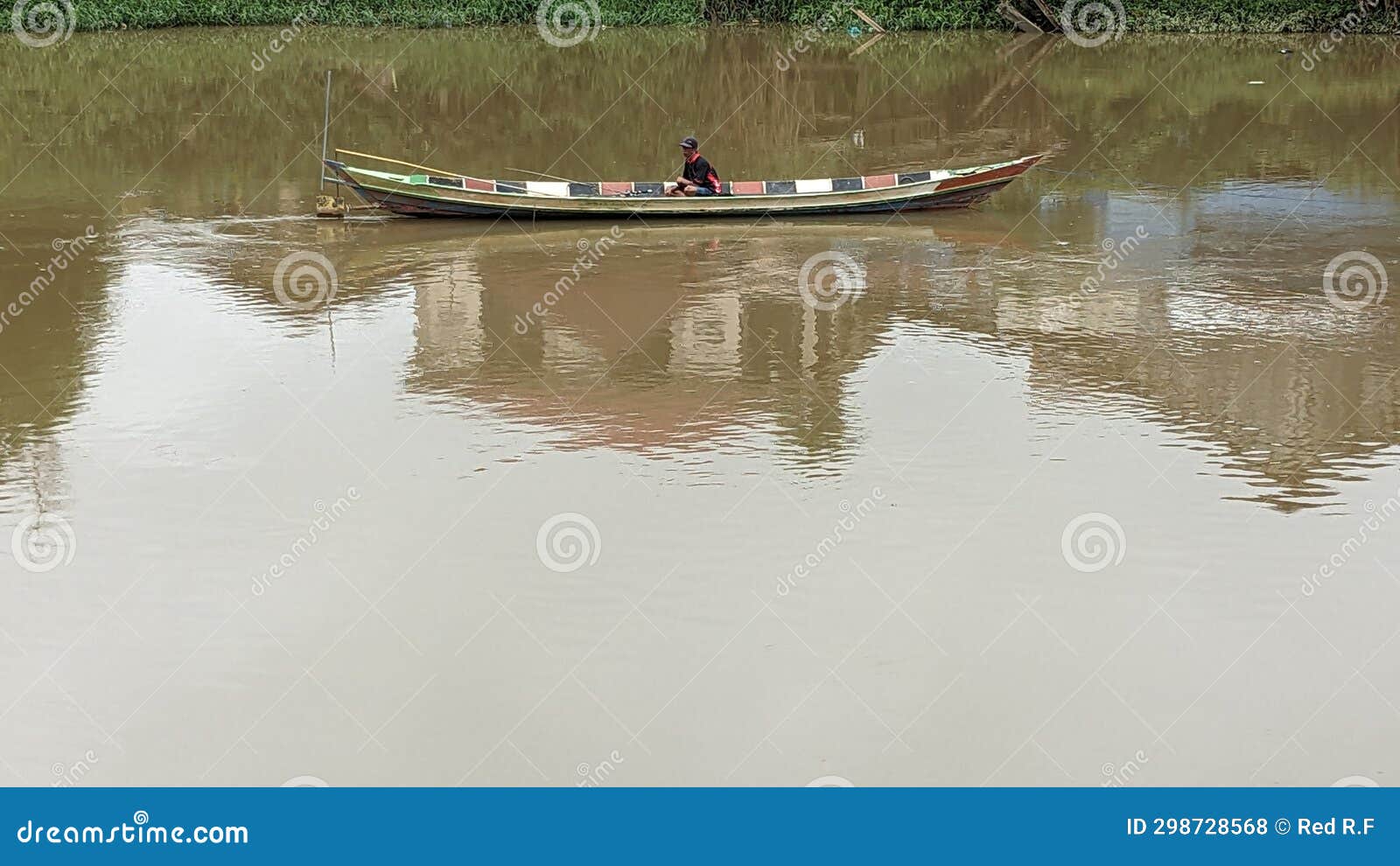A Fisherman Looking for Fish in the River Using a Boat Stock Photo ...