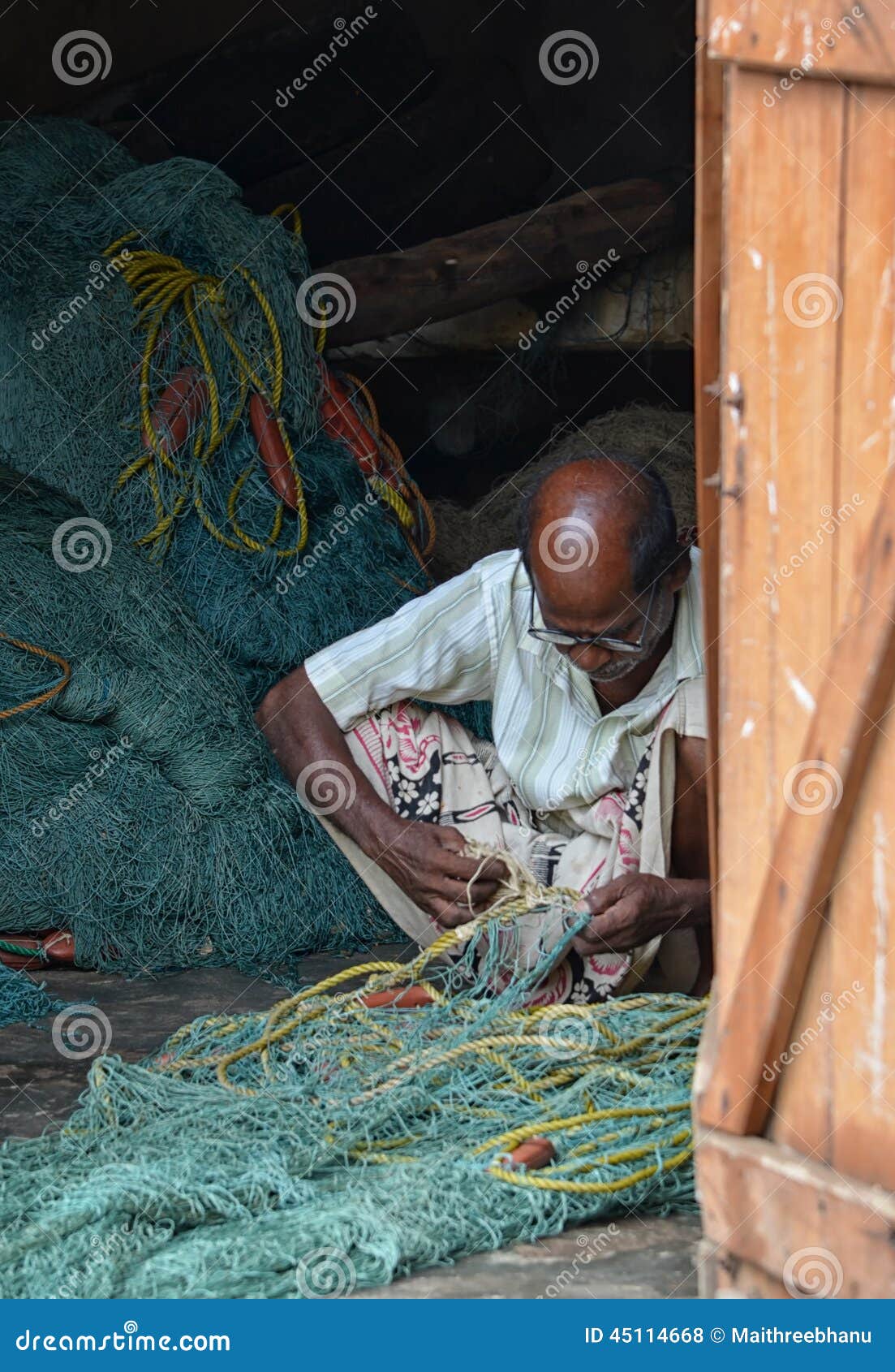 Fisherman Mending Nets editorial stock photo. Image of fisherman - 45114668