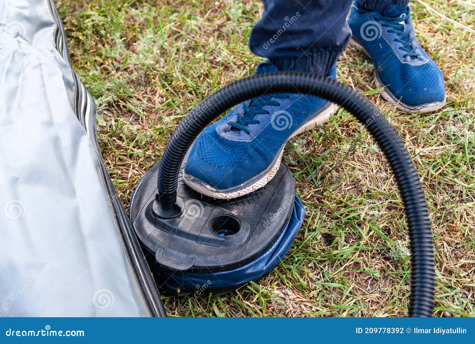 A Fisherman Pumps an Inflatable Boat with a Foot Pump. Inflatable Boat ...