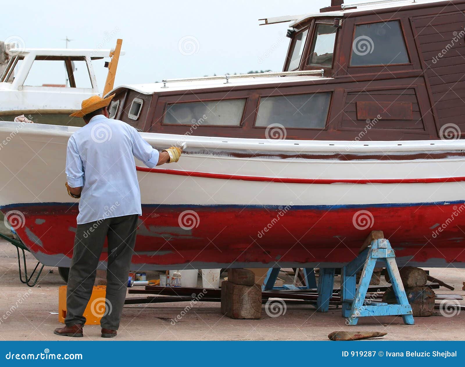 Fisherman repairs the boat stock image. Image of workers - 919287
