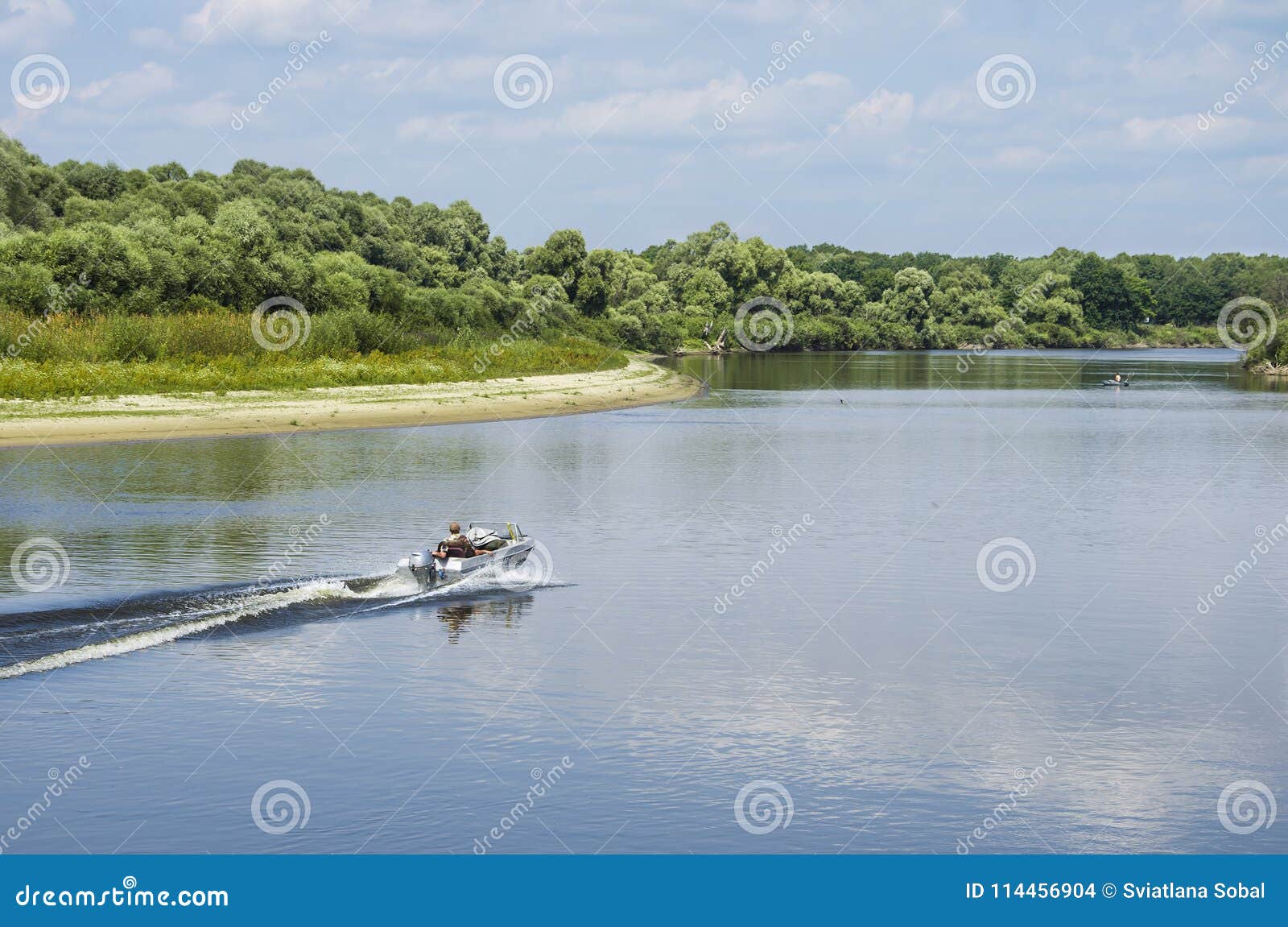 A Fisherman on a Motor Boat Rides the River Stock Photo - Image of ...