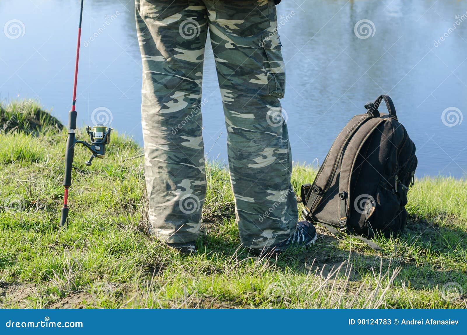 Fisherman on a River with a Spinning Rod and a Backpack Stock Image ...