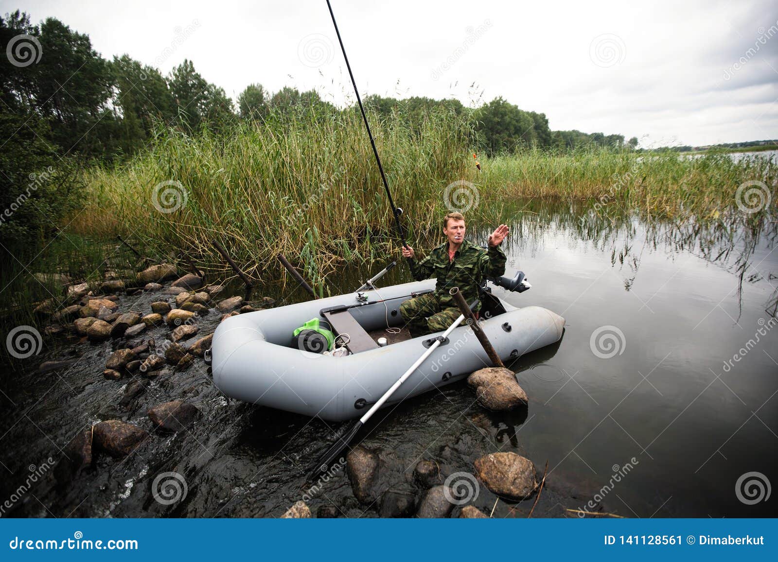 Fisherman on Rubber Boat Catching Fish on the River. Hobby. Stock Image ...