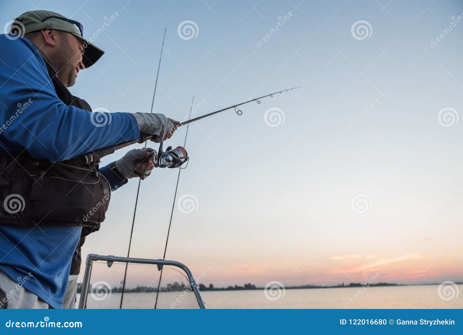 The Fisherman with a Spinning in His Hands from the Boat is Catching ...