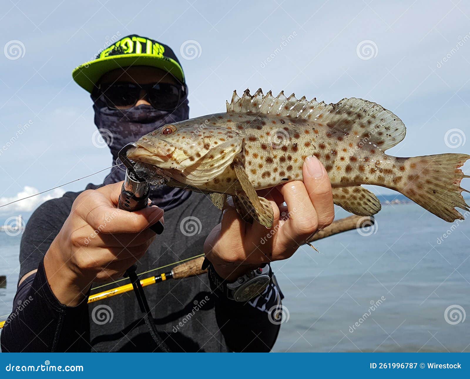 Fisherman in Sunglasses and Cap Holding a Fish Stock Image - Image of ...