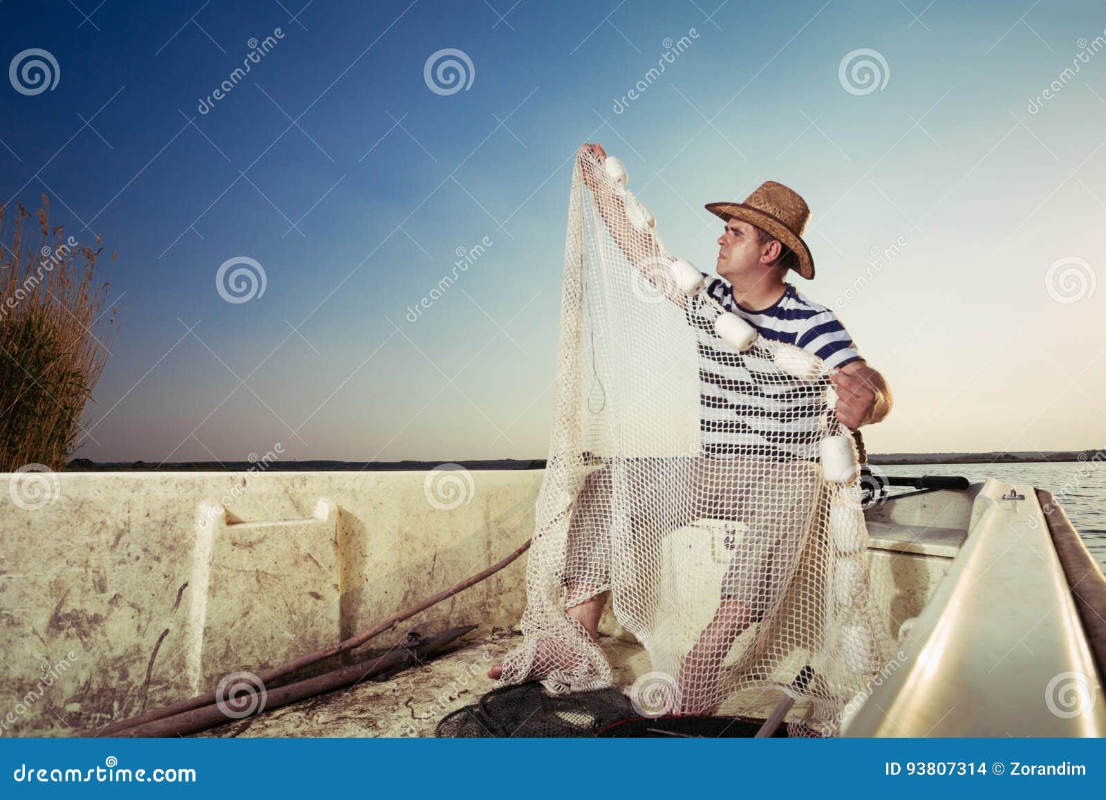 Fisherman throwing the net stock photo. Image of male - 93807314
