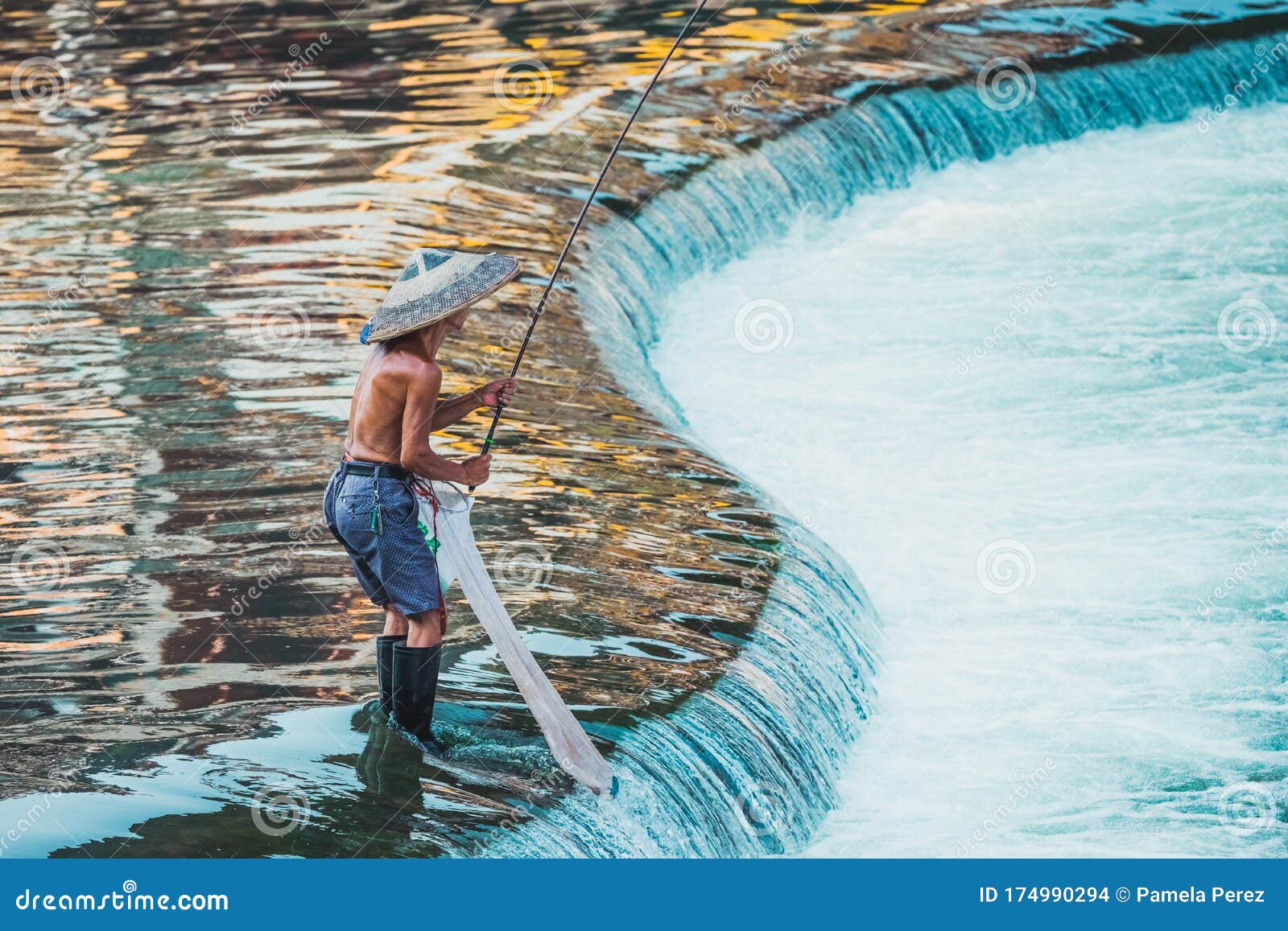 Fisherman with a Traditional Triangular Chinese Hat Standing in Waters ...